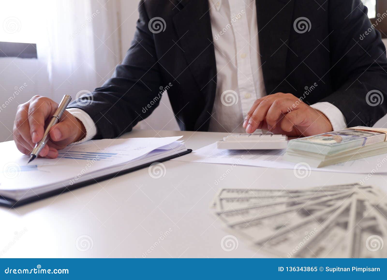 Businessman Using Calculator with Money on the Desk. Stock Image ... Businessman Using Calculator with Money on the Desk. Stock Image ...