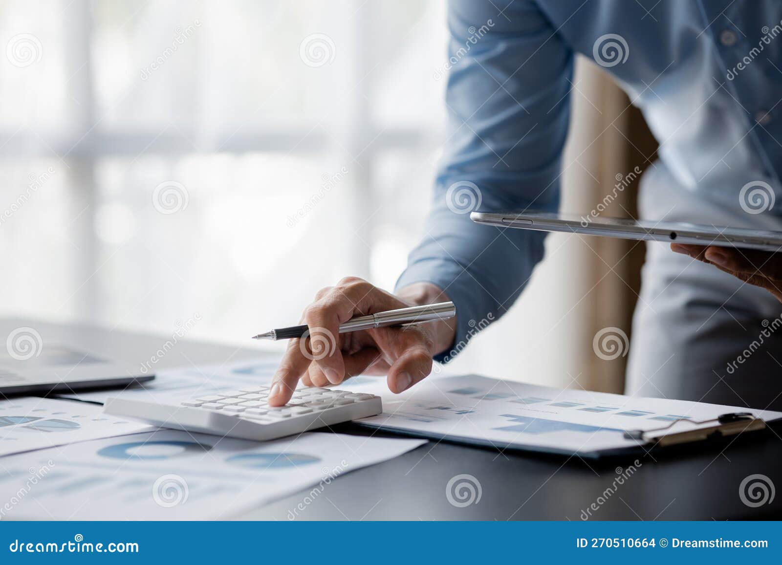 Businessman is Using a Calculator To Calculate Company Financial ... Businessman is Using a Calculator To Calculate Company Financial ...
