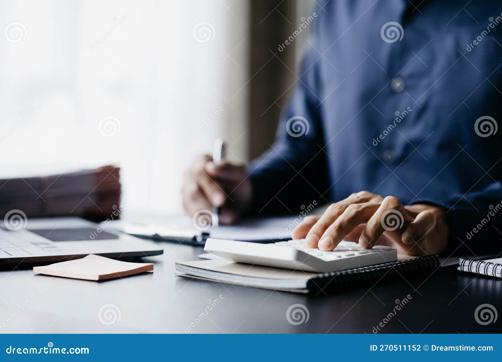 Businessman is Using a Calculator To Calculate Company Financial ... Businessman is Using a Calculator To Calculate Company Financial ...