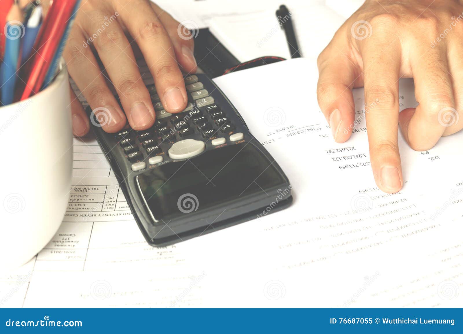 Businessman Using a Calculator To Calculate the Numbers. Accounting ...