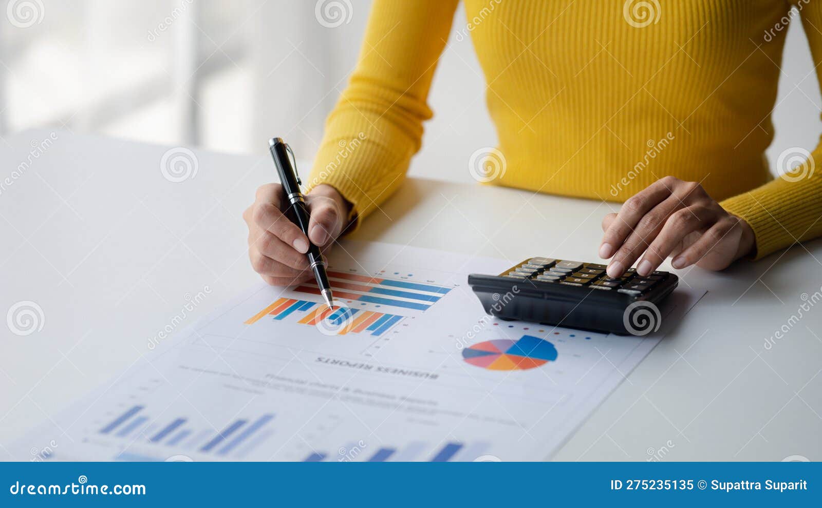 Businessman Using a Calculator To Calculate Numbers on a Company S ...