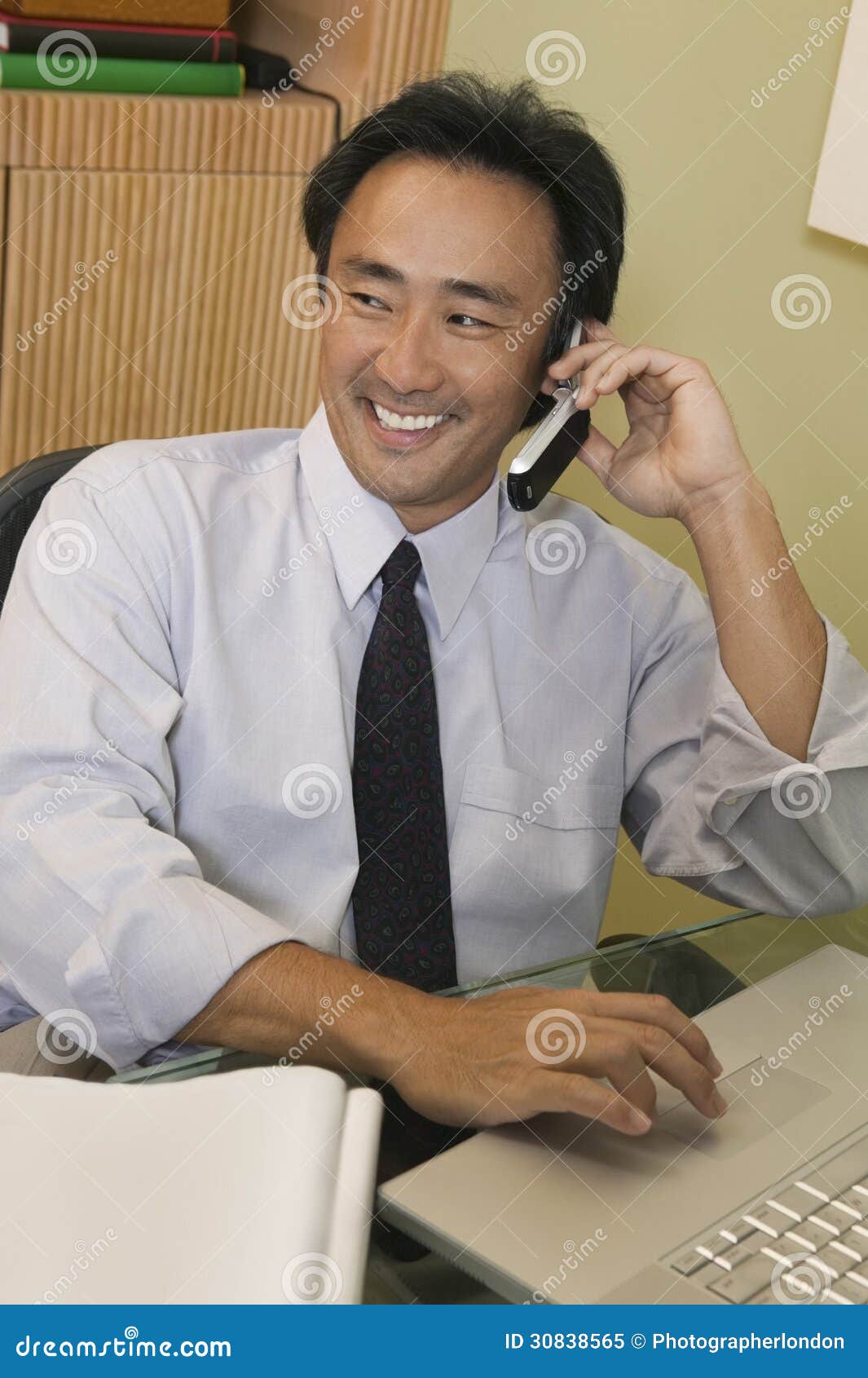 Businessman Using Cell Phone and Laptop at Work Stock Image - Image of ...