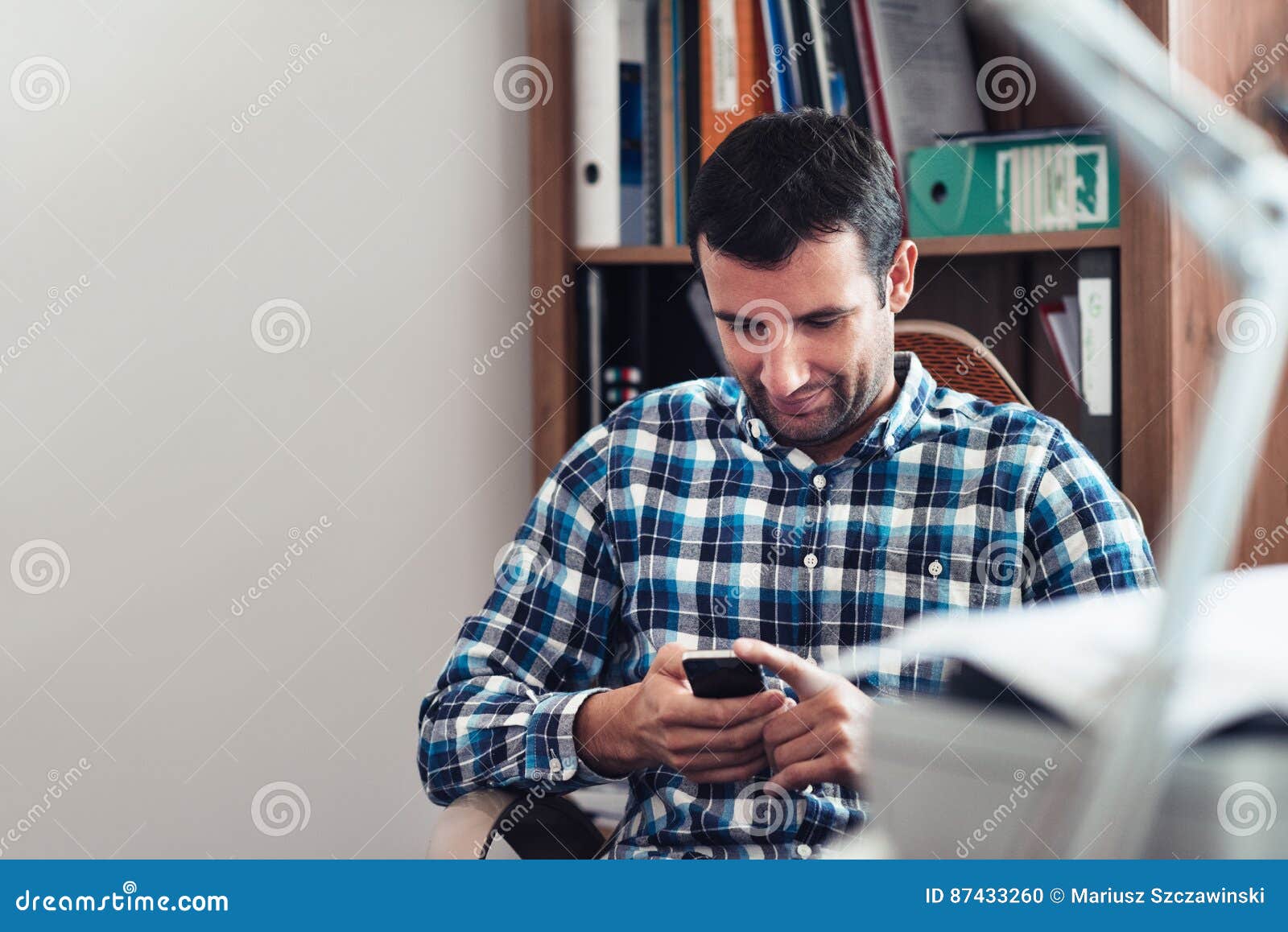 Businessman Using a Cellphone at an Office Desk Stock Photo - Image of ...