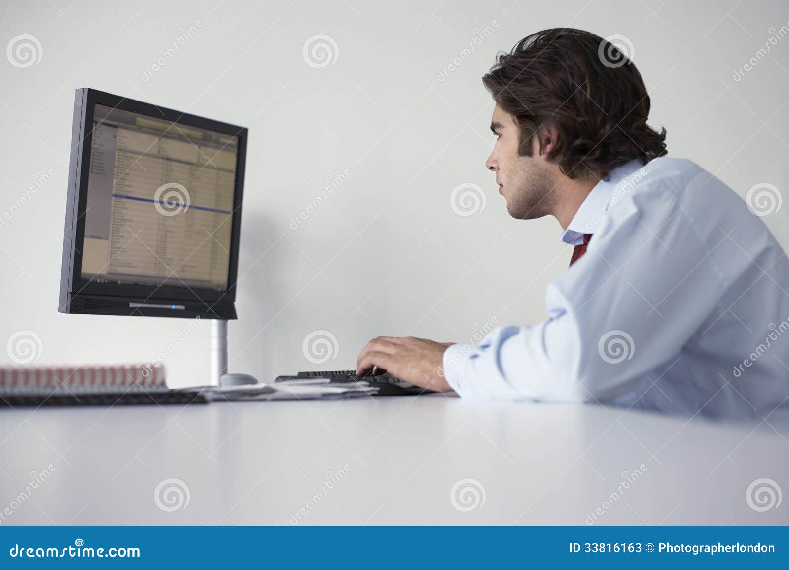 Businessman Using Computer stock image. Image of looking - 33816163