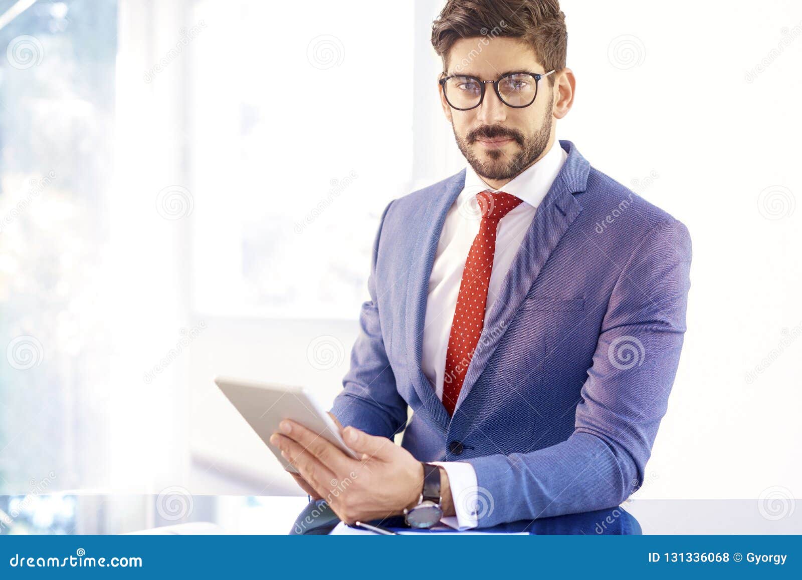 Businessman Using Digital Tablet while Working at Office Desk Stock ... Businessman Using Digital Tablet while Working at Office Desk Stock ...