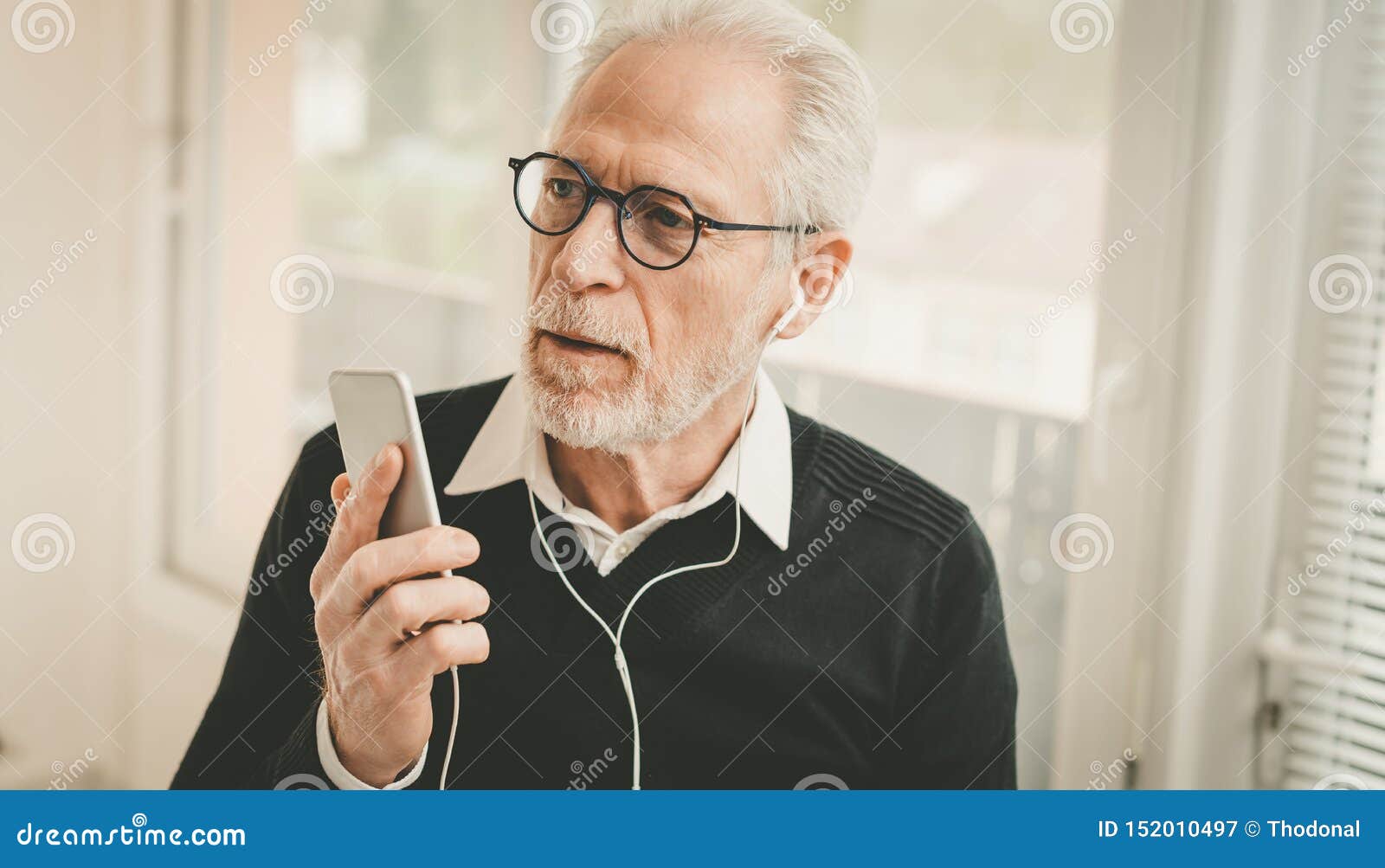 Businessman Using Earphones during Conversation on Mobile Phone Stock ...