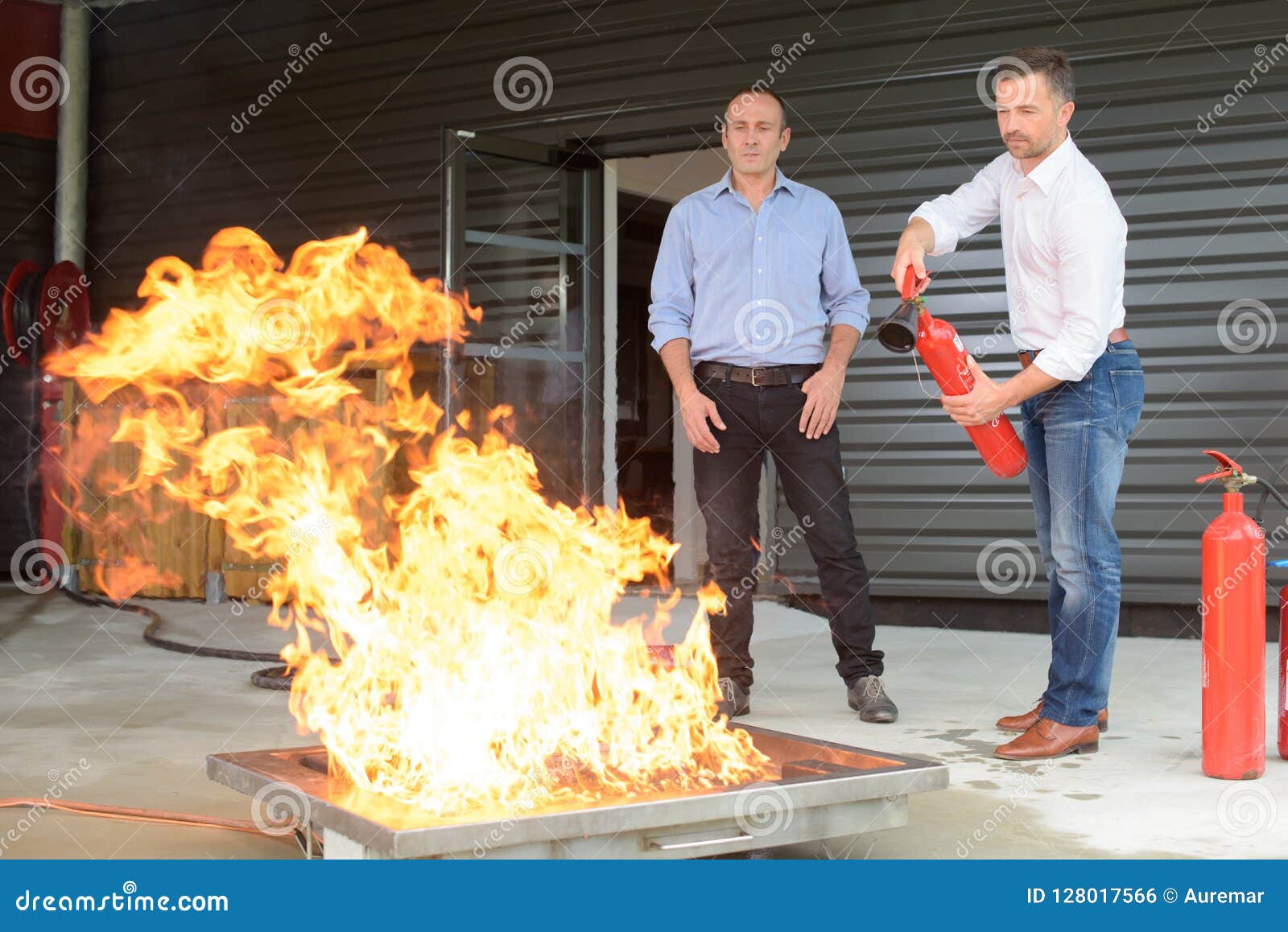Businessman Using Fire Extinguisher during Fire Training Stock Photo ...