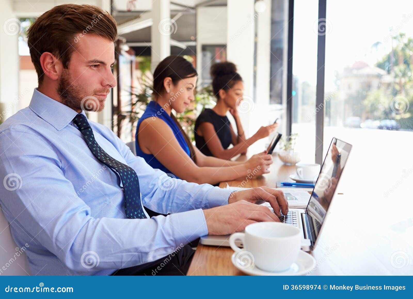 Businessman Using Laptop in Coffee Shop Stock Photo - Image of people ...