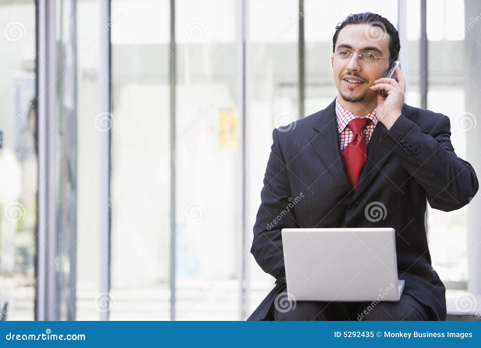 Businessman Using Laptop and Mobile Phone Outside Stock Image - Image ...