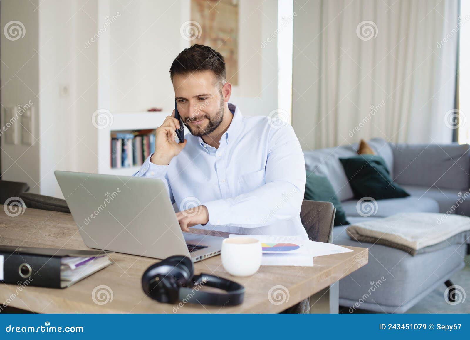Businessman Using Laptop and Mobile Phone while Working from Home Stock ...
