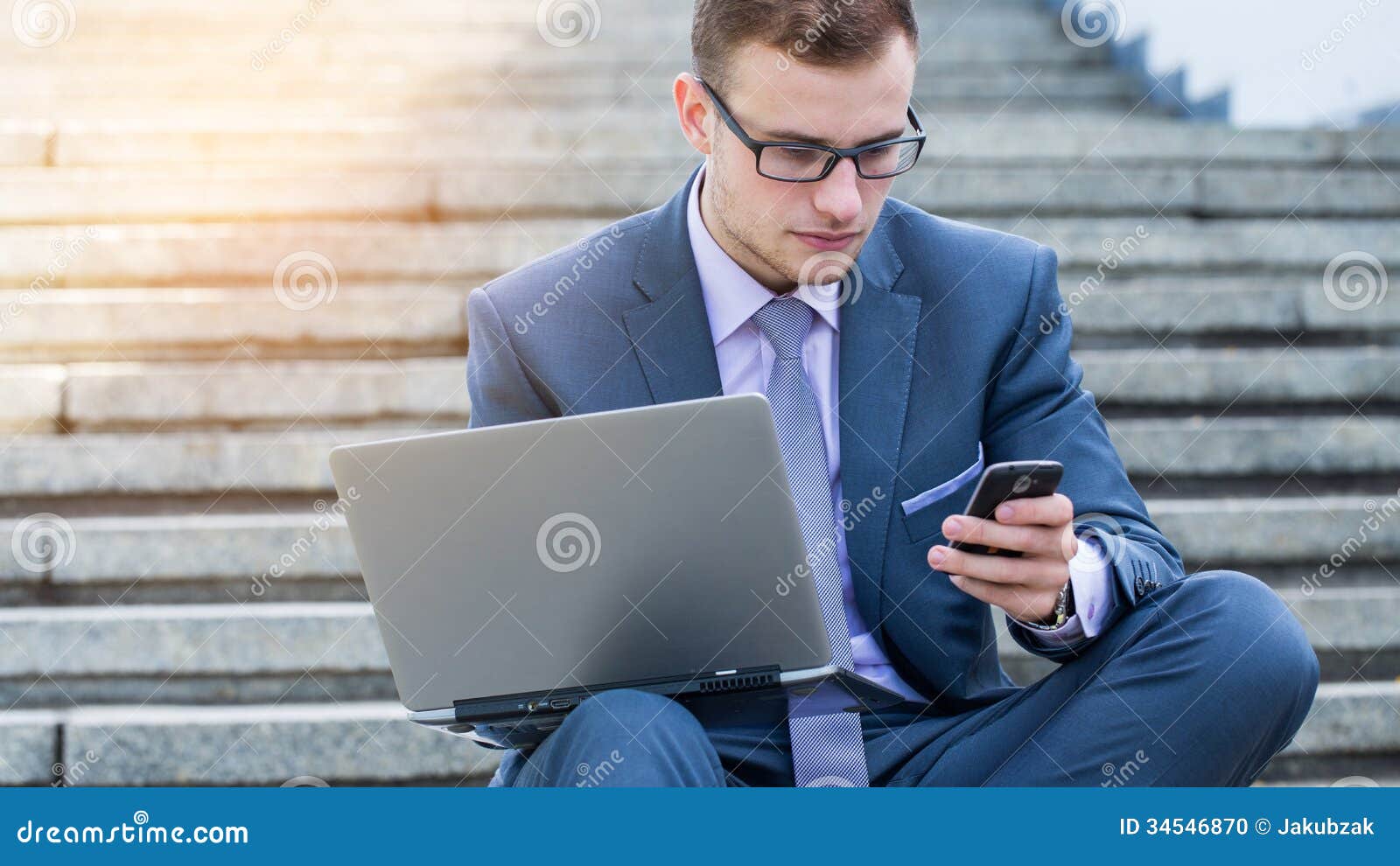 Businessman Using Laptop Pc and Mobile Phone. he is Sitting on a Stairs ...