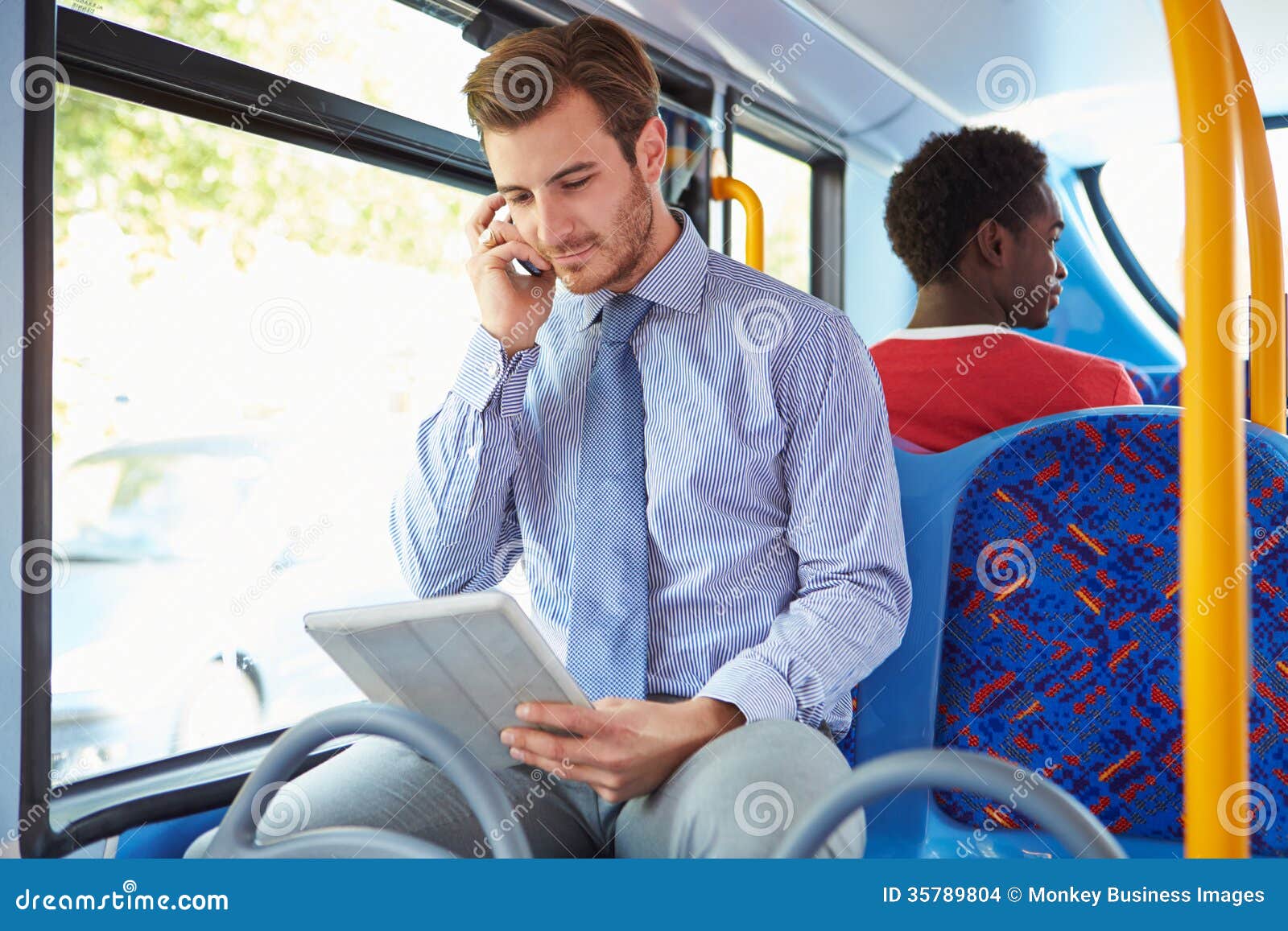 Businessman Using Mobile Phone and Digital Tablet on Bus Stock Photo ...