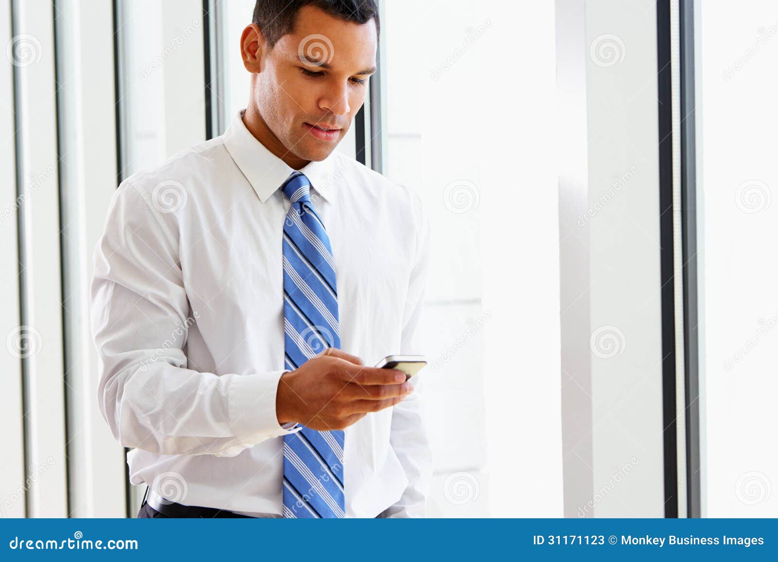 Businessman Using Mobile Phone in Office Stock Image - Image of cell ...