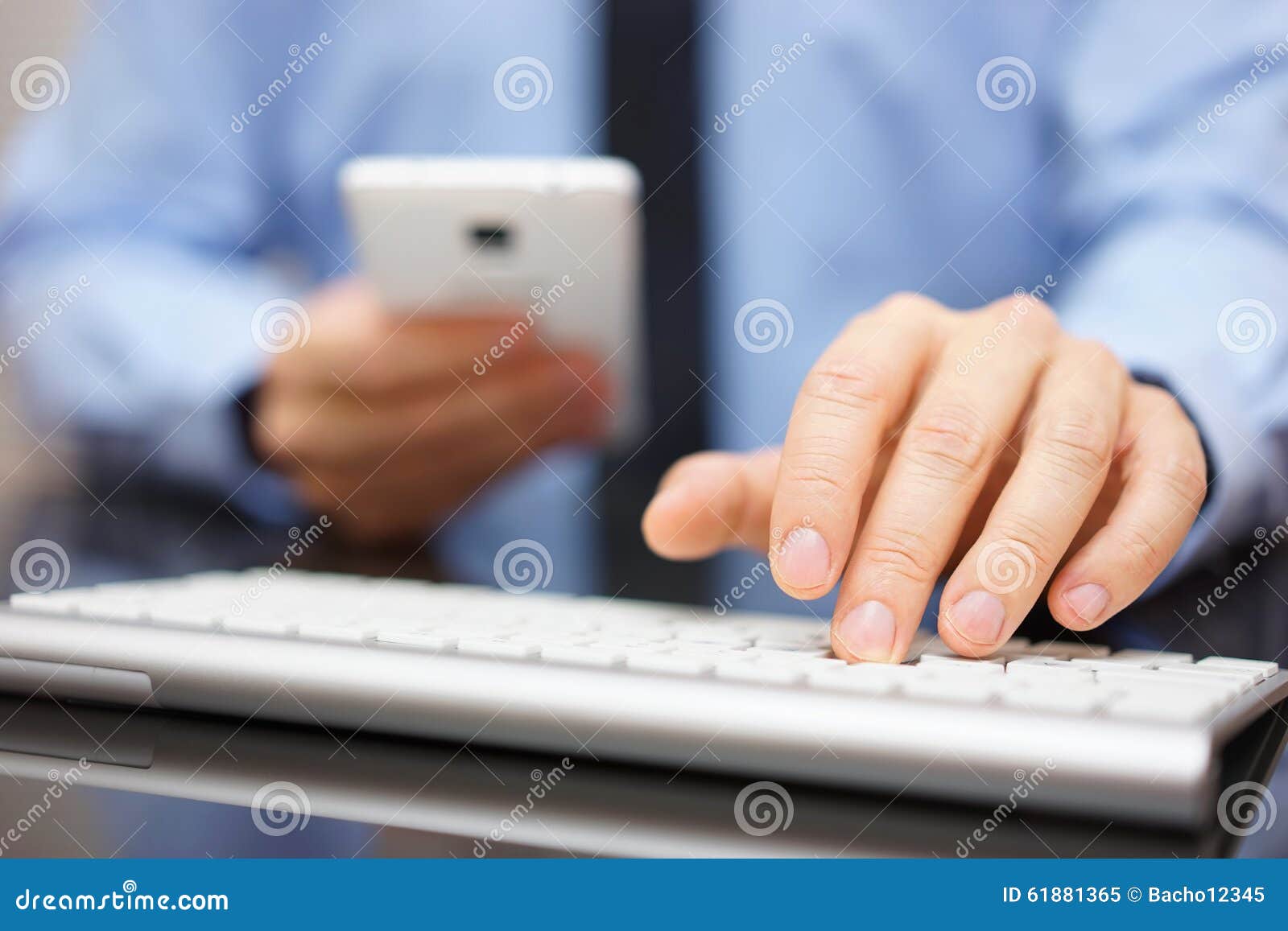 Businessman is Using Phablet while Typing on Computet Keyboard Stock ...