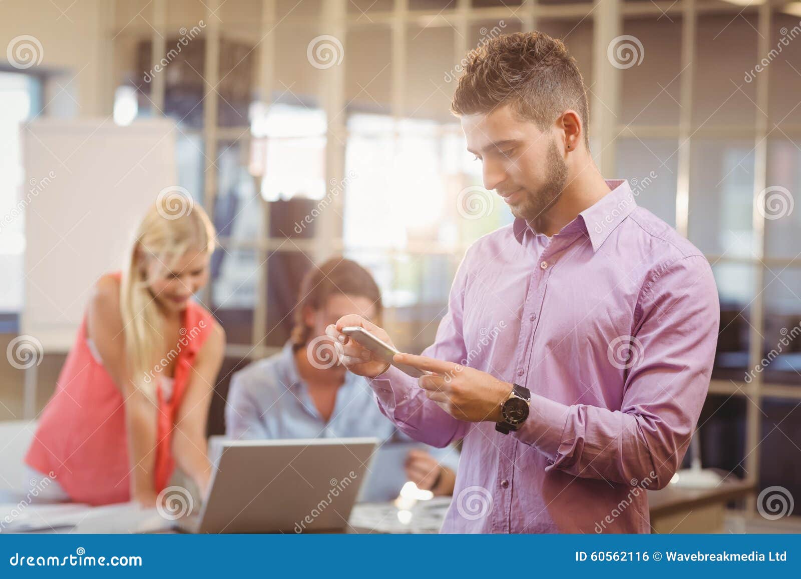 Businessman Using on Phone in Office with Colleagues Working Stock ...