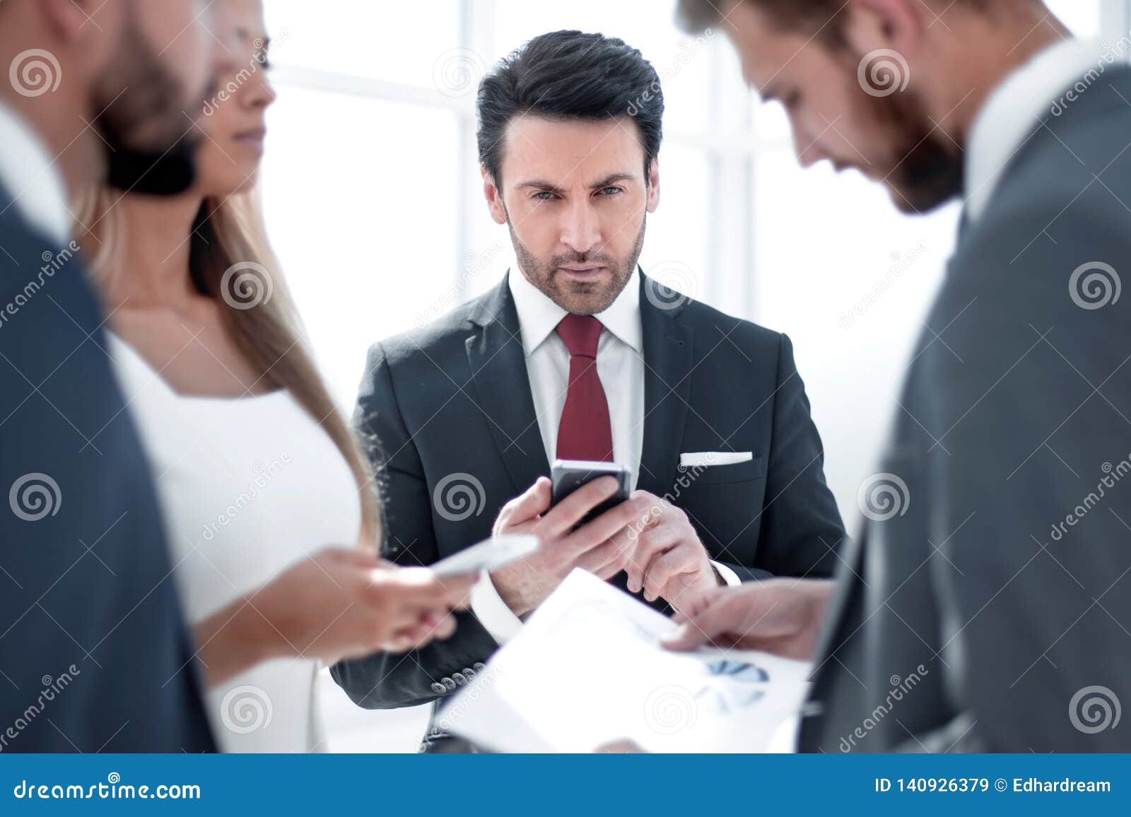 Businessman Using a Smartphone at a Meeting in the Office Stock Image ...