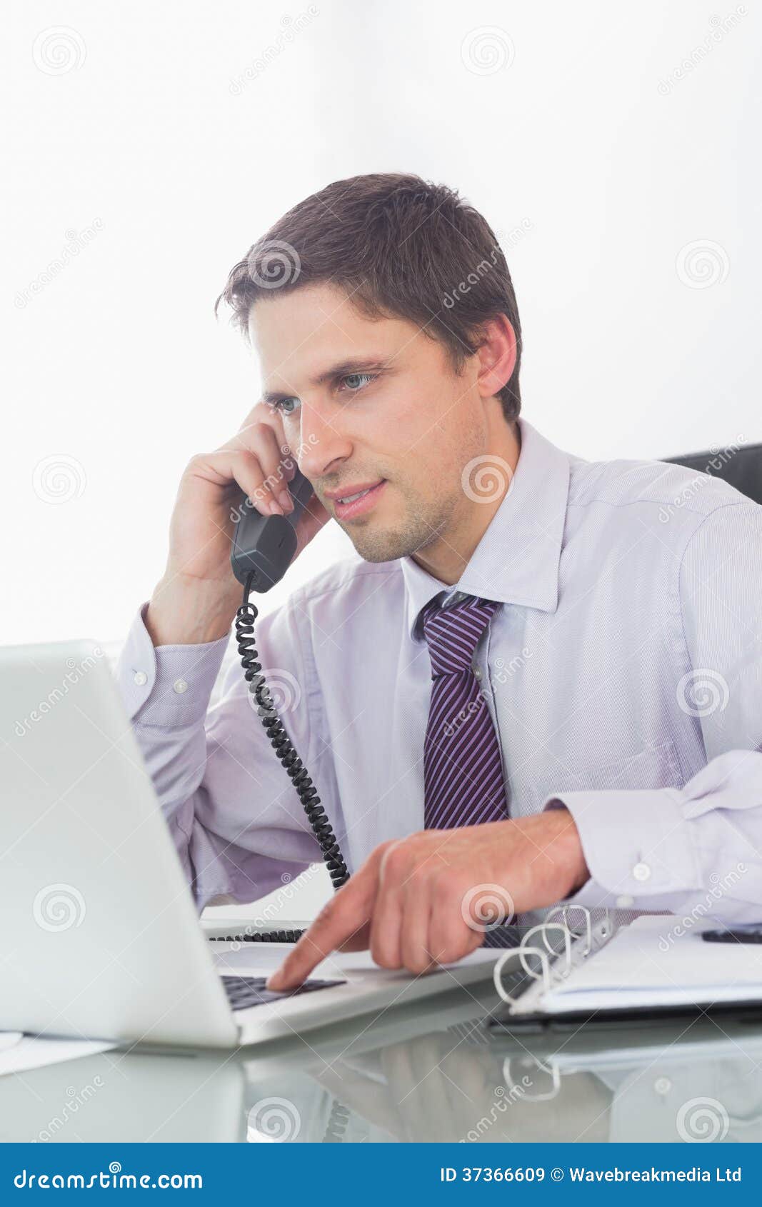 Businessman Using Telephone and Laptop at Desk Stock Image - Image of ...