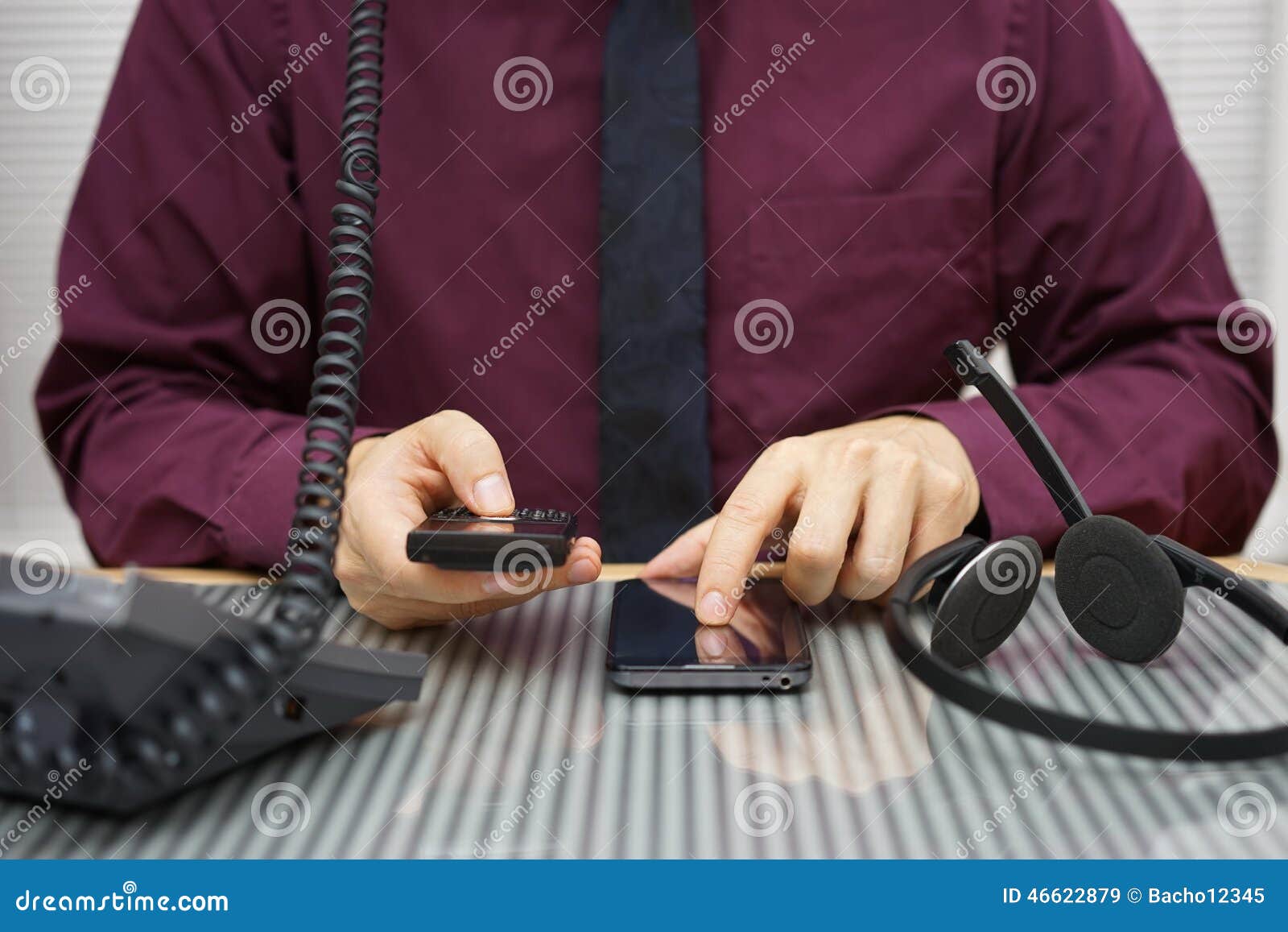 Businessman is Using Two Mobile Phones and Landline Telephone at Stock ...