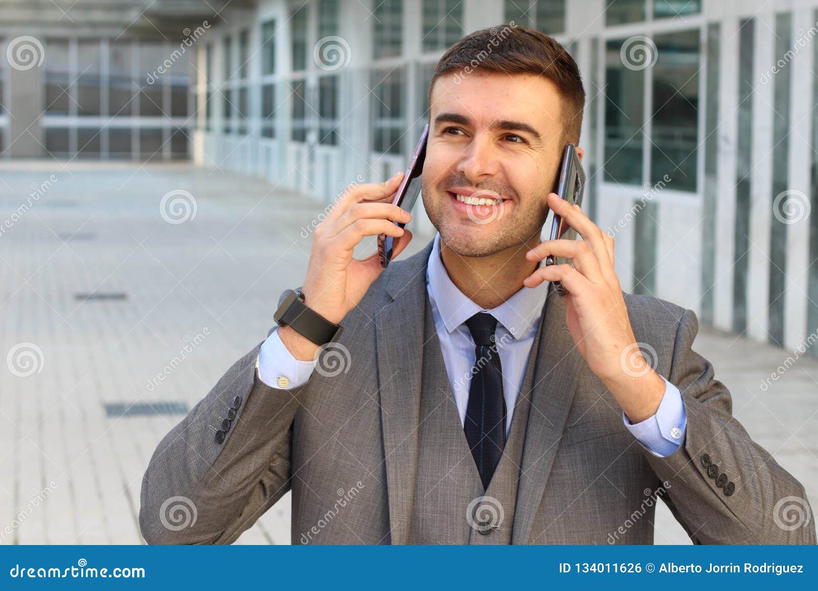 Businessman Using Two Phones Simultaneously Stock Photo - Image of ... Businessman Using Two Phones Simultaneously Stock Photo - Image of ...