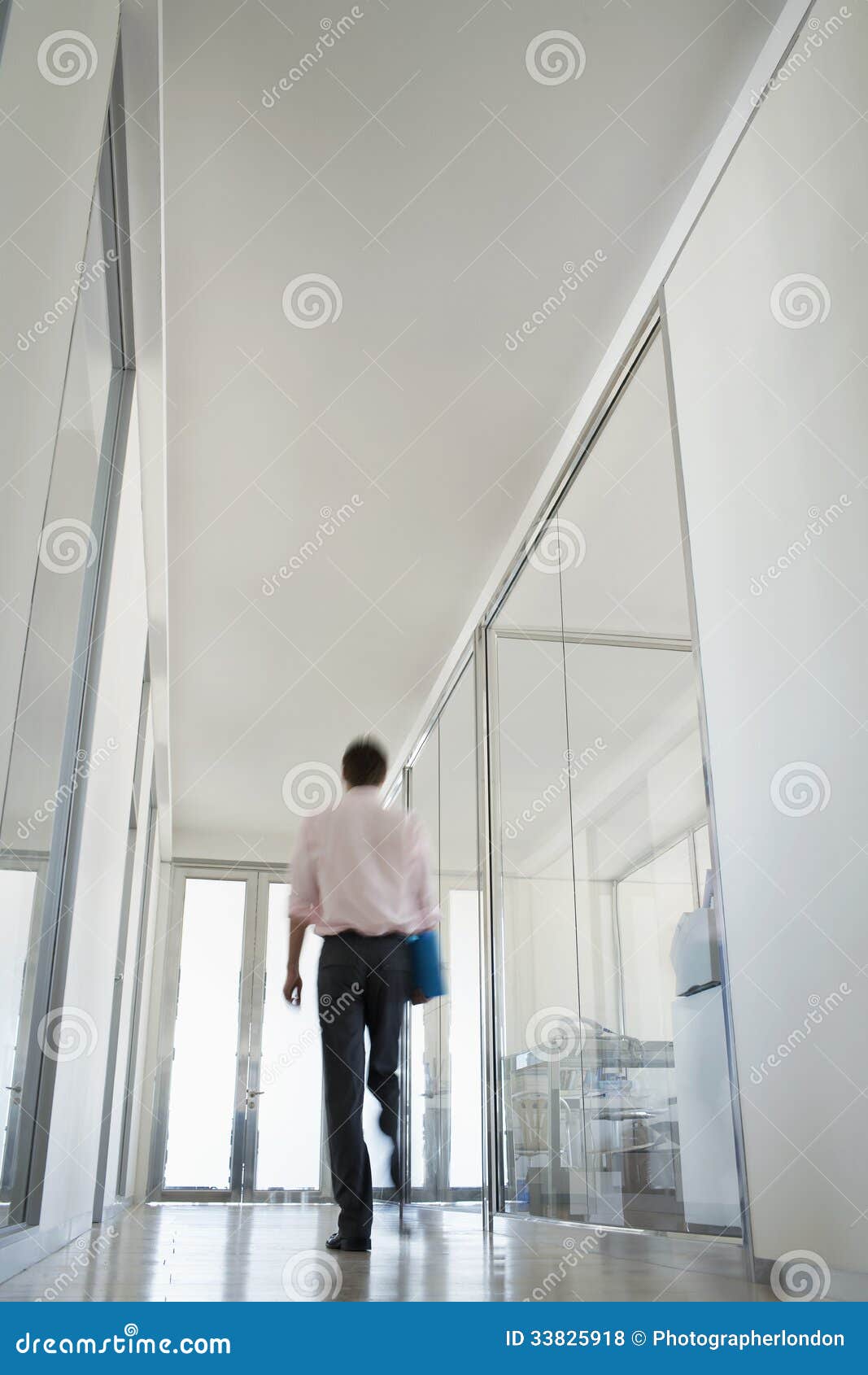 Businessman Walking in Corridor Stock Photo - Image of businessperson ...