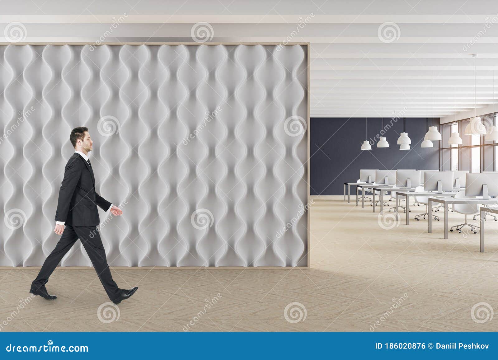 Businessman Walking in Office Interior with Computers and White Blank ...