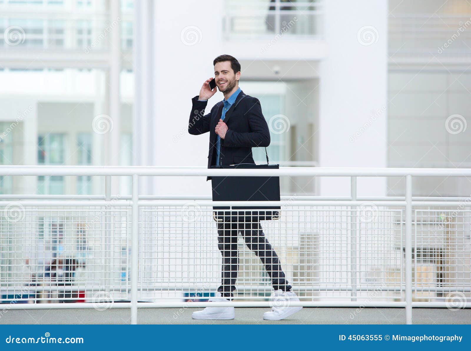Businessman Walking and Talking on Mobile Phone Stock Image - Image of ...