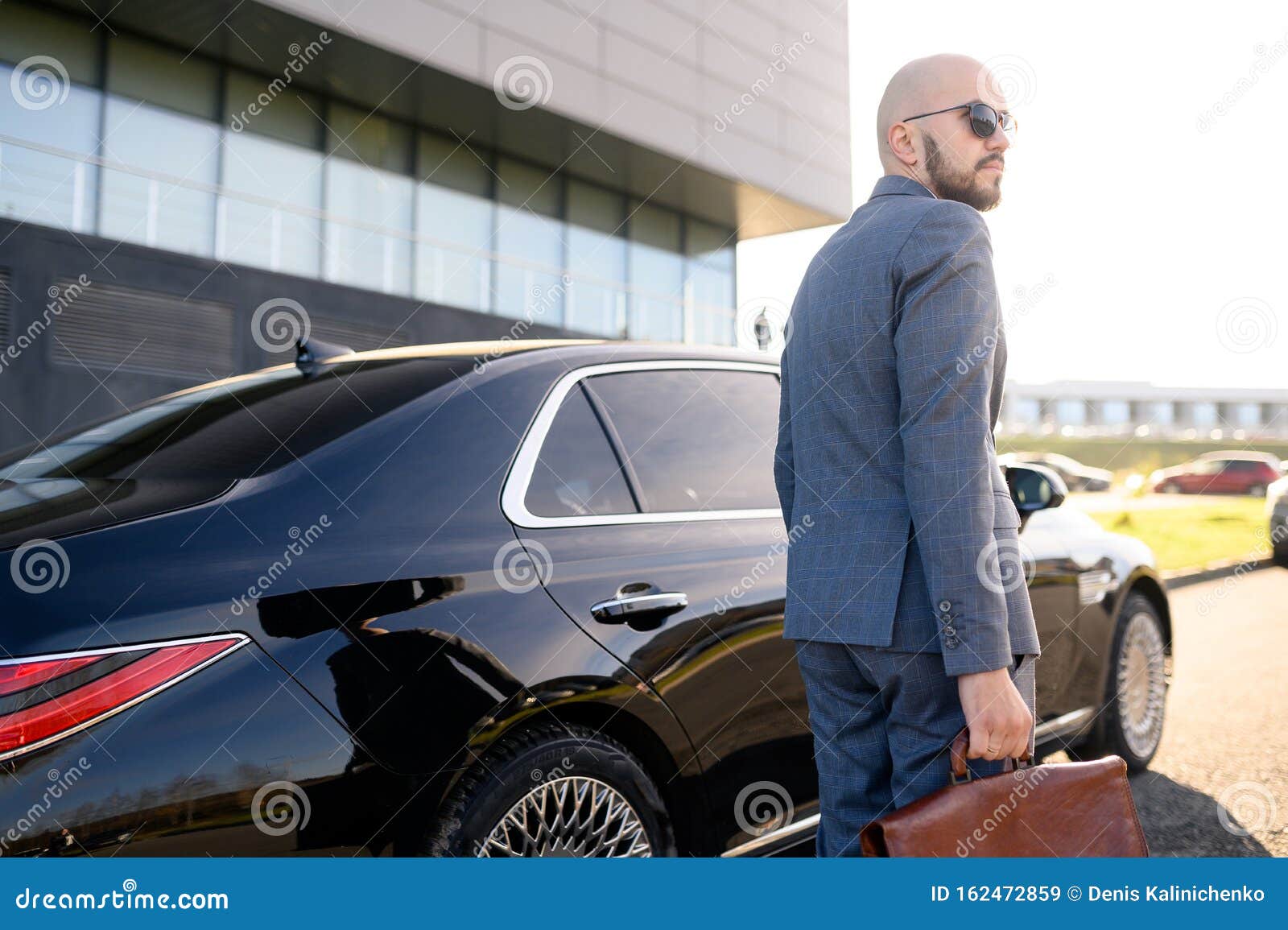 Businessman Walks on the Background of a Building and a Car Stock Image ...
