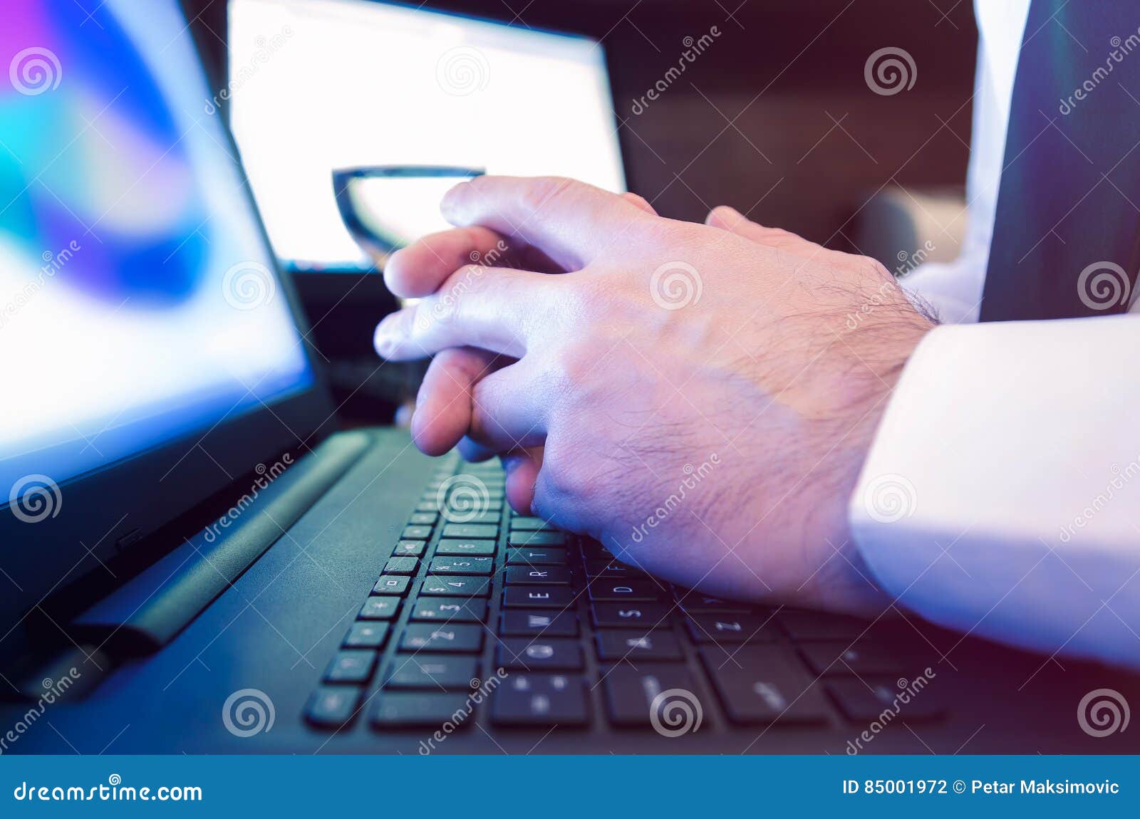 Businessman Watching Over Computer Screens in Office with Crossed Hands ...