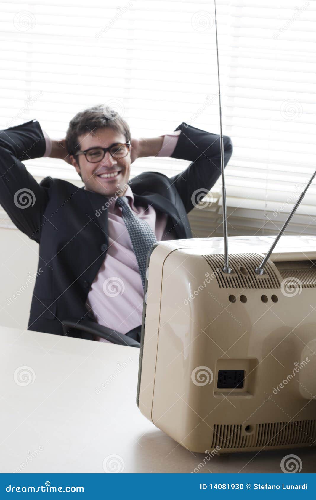 Businessman watching TV stock photo. Image of office - 14081930