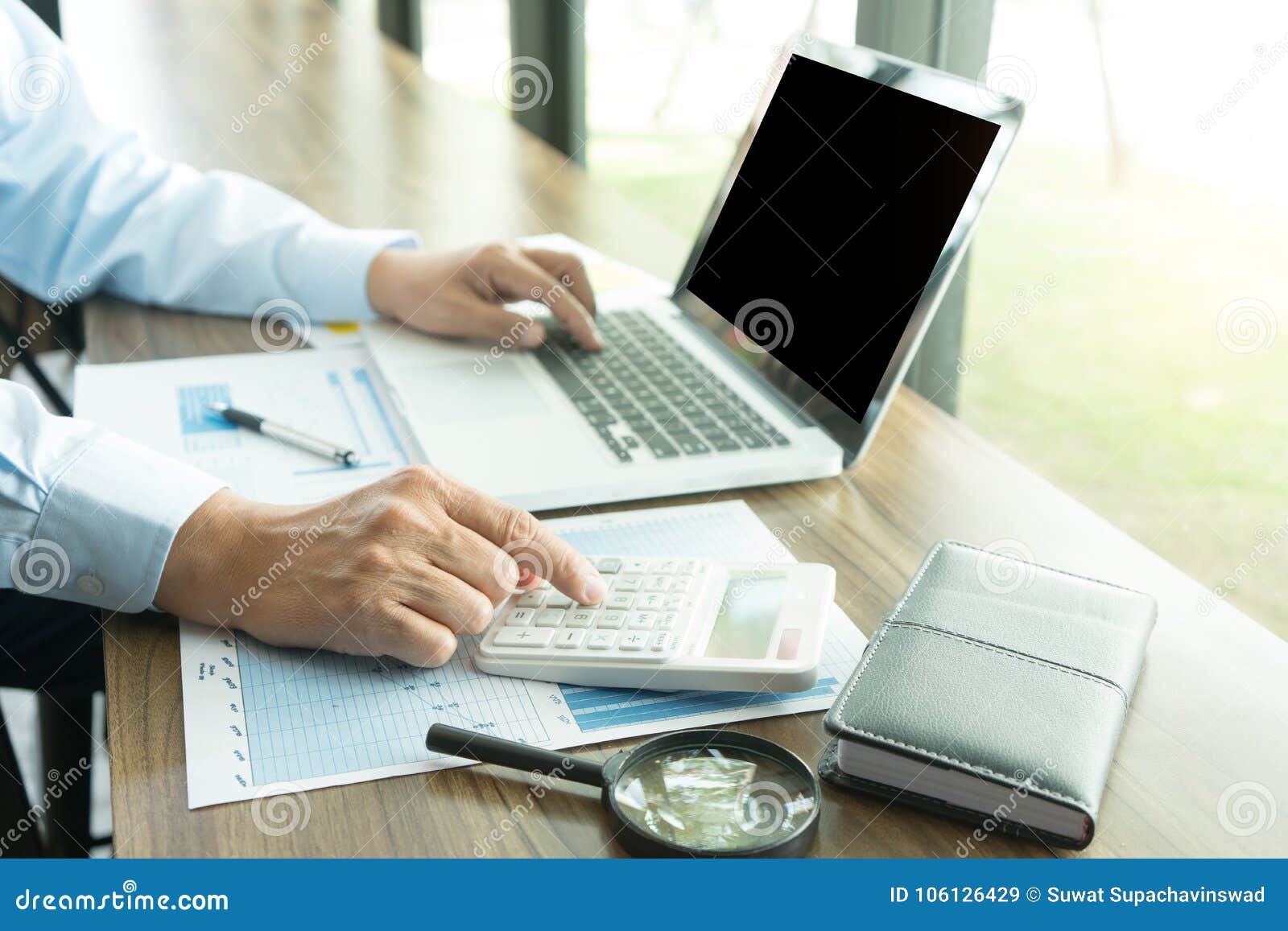 Businessman Work with Computer on Table in Office Work with Paper Graph ...