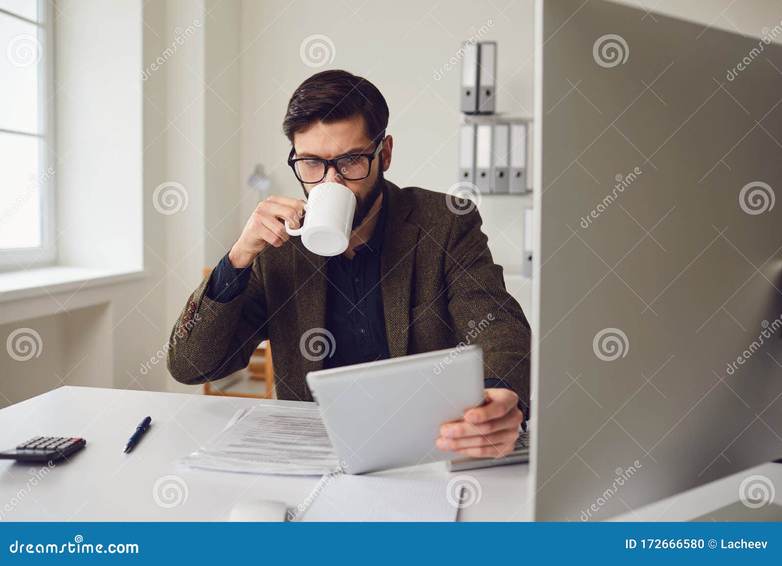Businessman Worker Drinking a Coffee Mug while Sitting at a Table with ...
