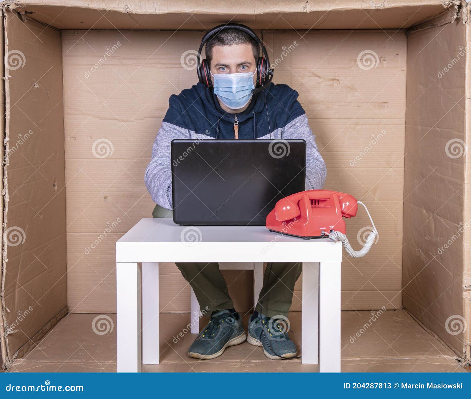 Businessman Working in a Cramped Office, Minimizing Space Stock Image ...