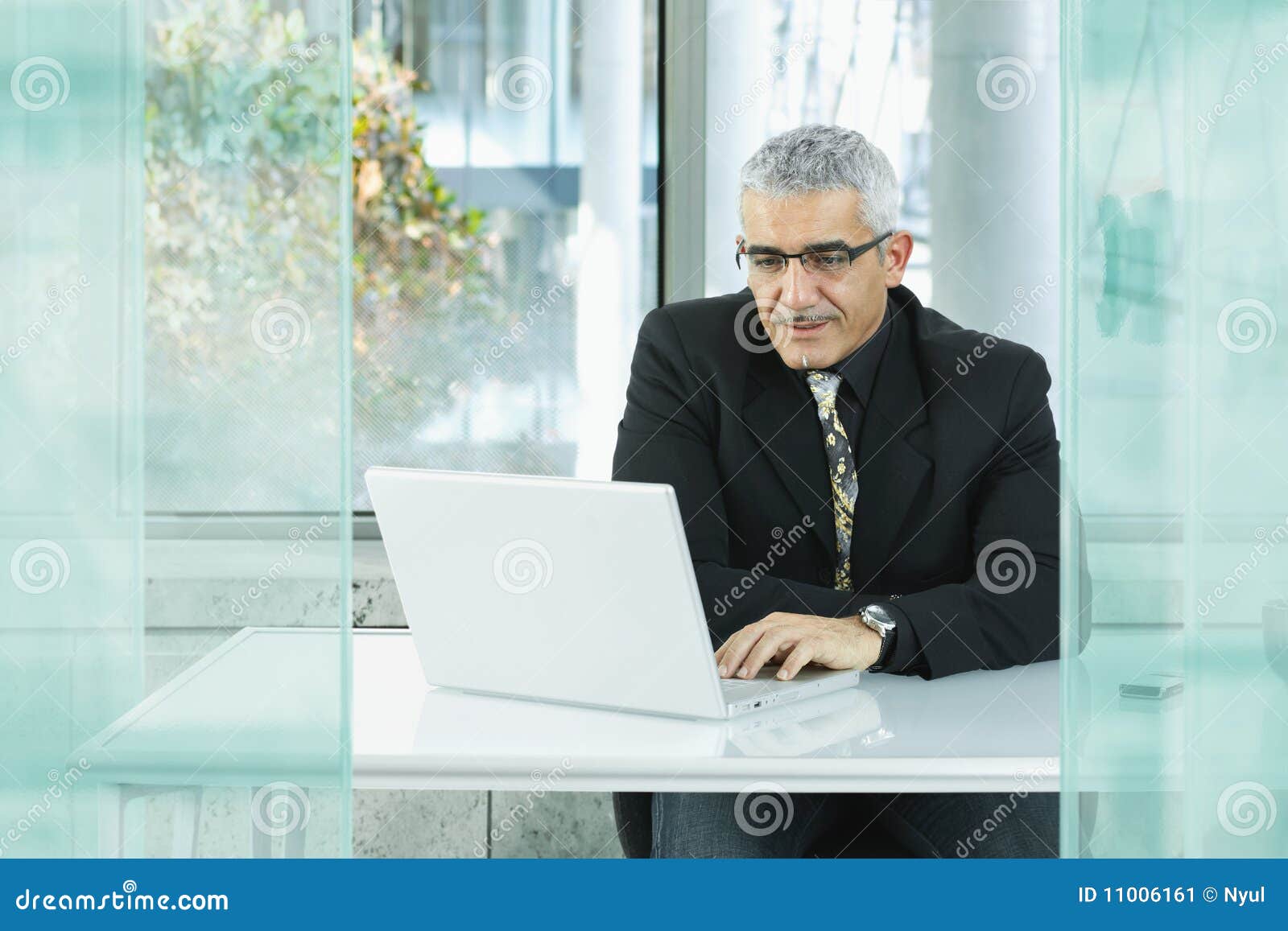 Businessman Working at Desk Stock Image - Image of glass, grey: 11006161