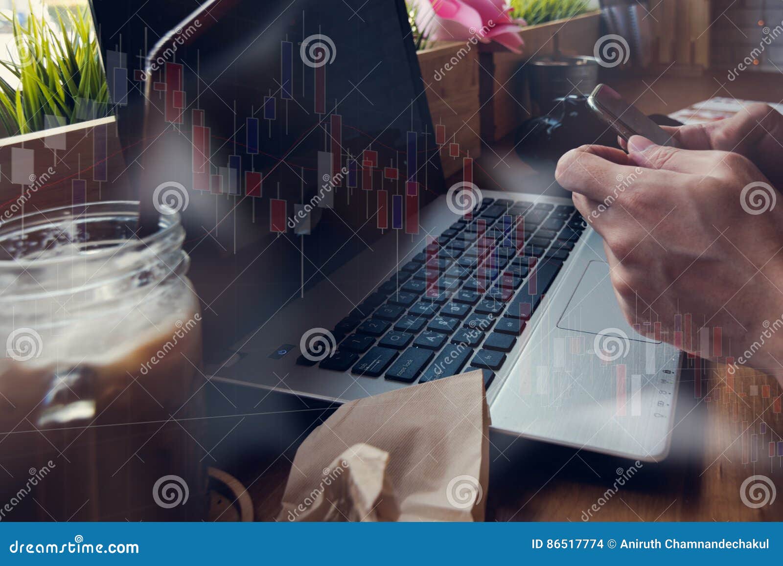 Businessman is Working with His Computer in Coffee Shop with Stock ...