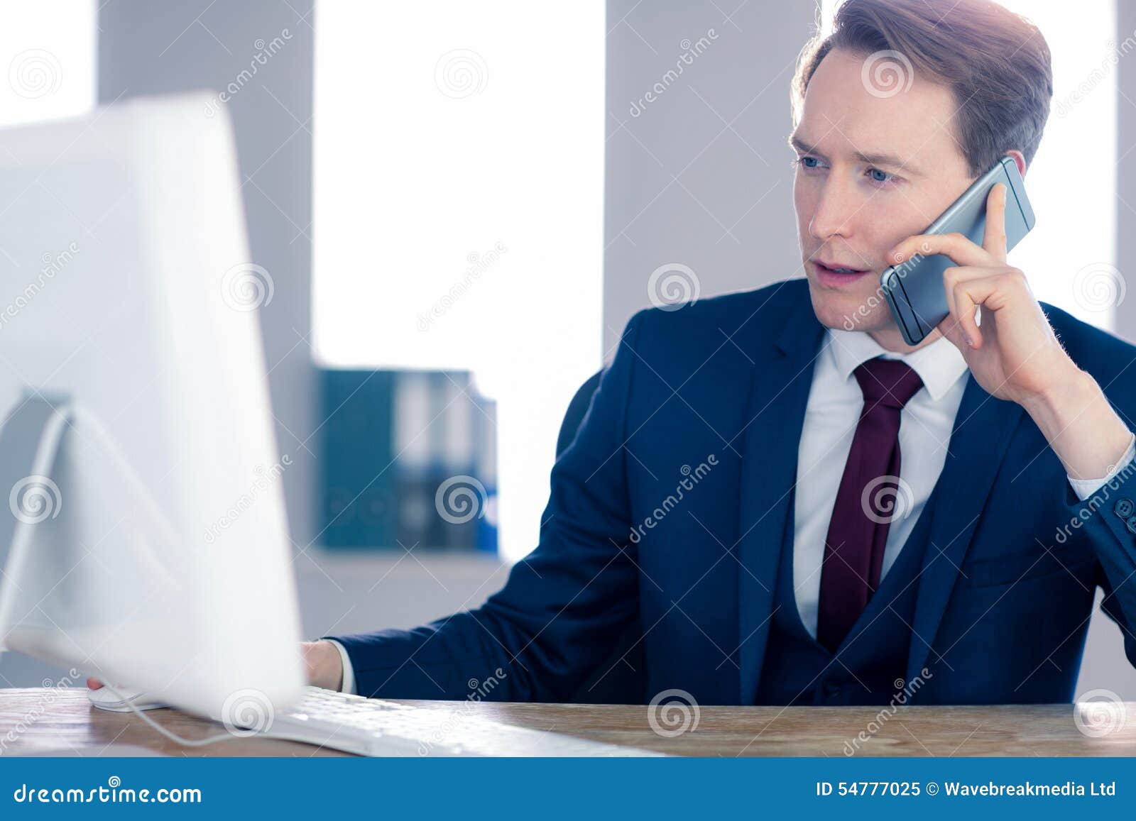 Businessman Working on His Computer and Having a Phone Call Stock Image ...