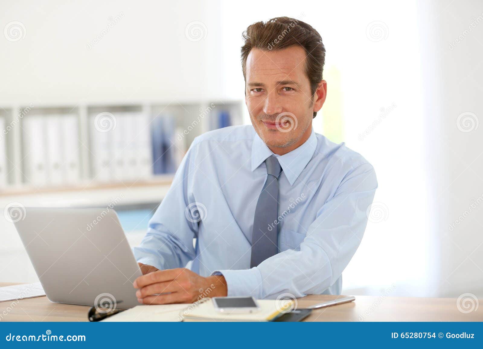 Businessman Working on Laptop Stock Photo - Image of handsome, business ...