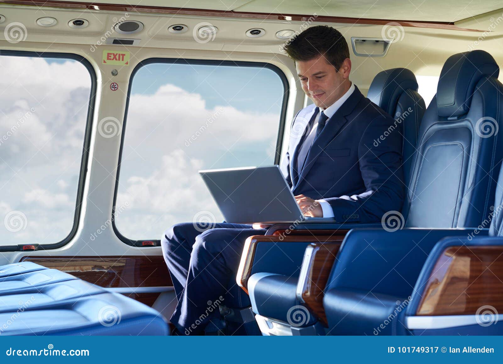 Businessman Working on Laptop in Helicopter Cabin during Flight Stock ...