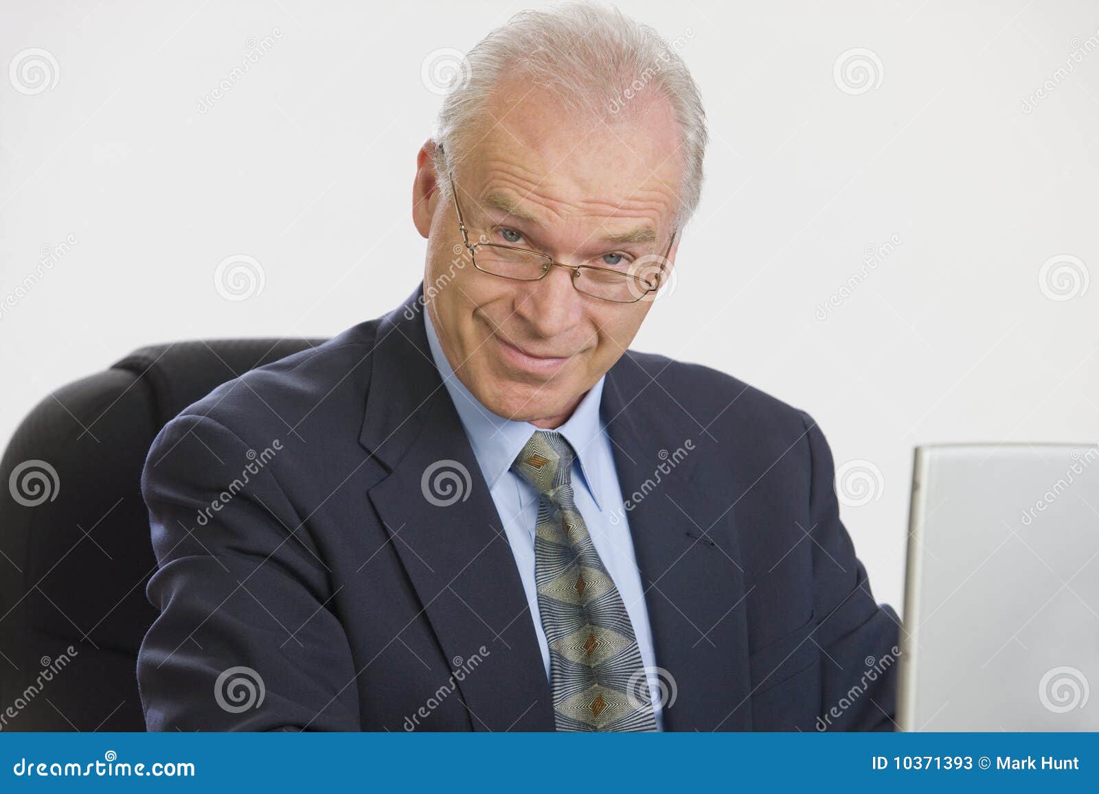 Businessman Working on Laptop Looking at Camera. Stock Image - Image of ...