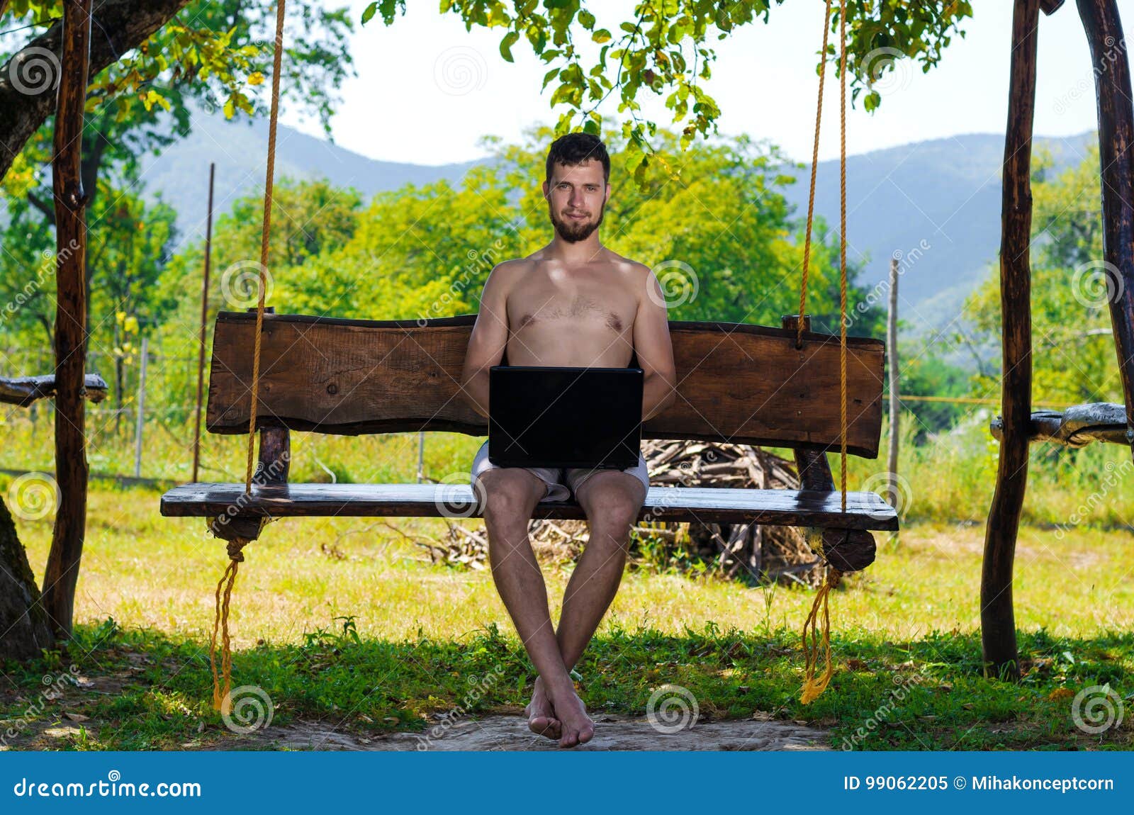 Businessman Working on a Laptop Sitting on a Swing, Working and Stock ... Businessman Working on a Laptop Sitting on a Swing, Working and Stock ...