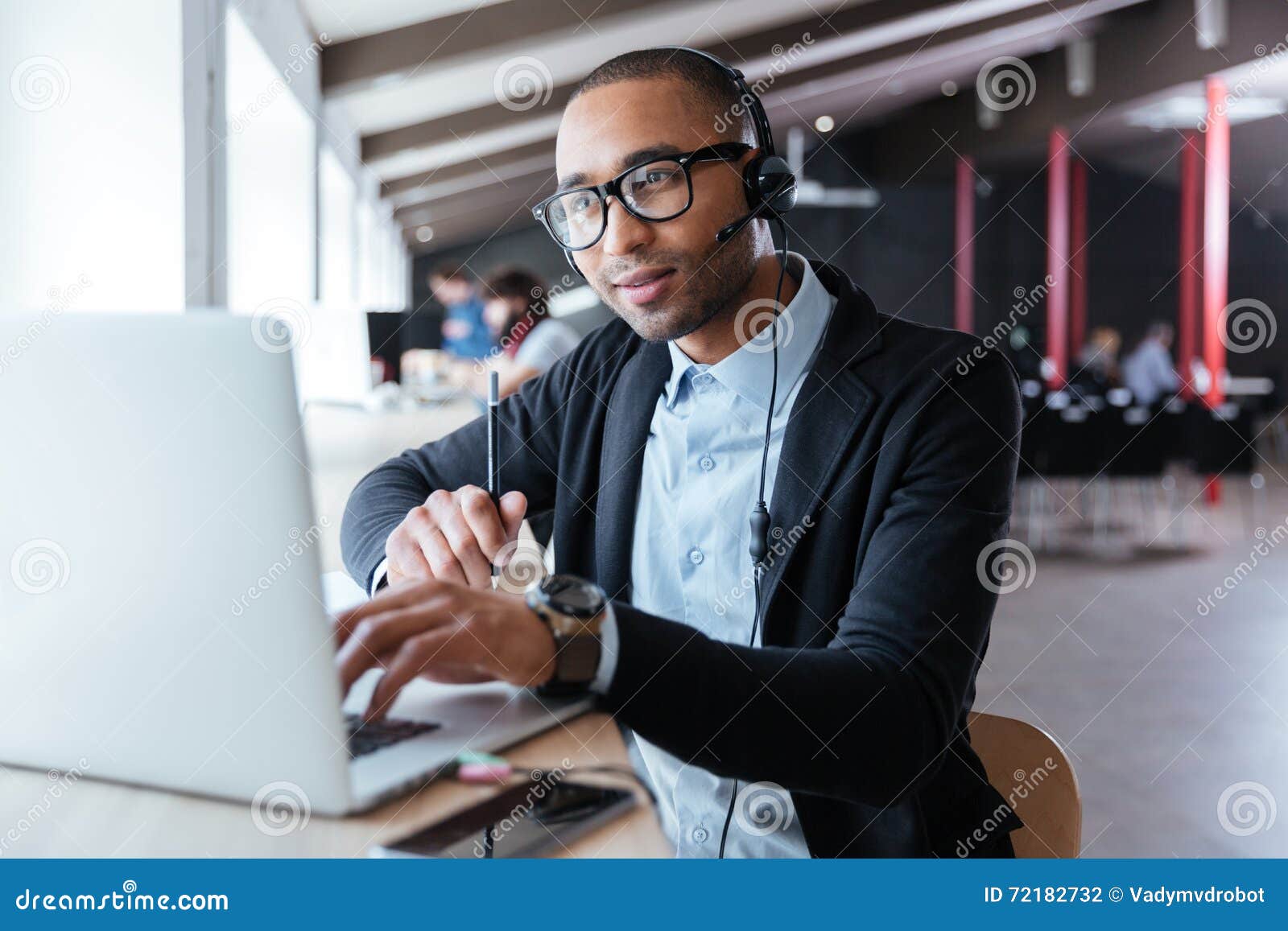 Businessman Working with Laptop Using Headphones and Microphone Stock ...