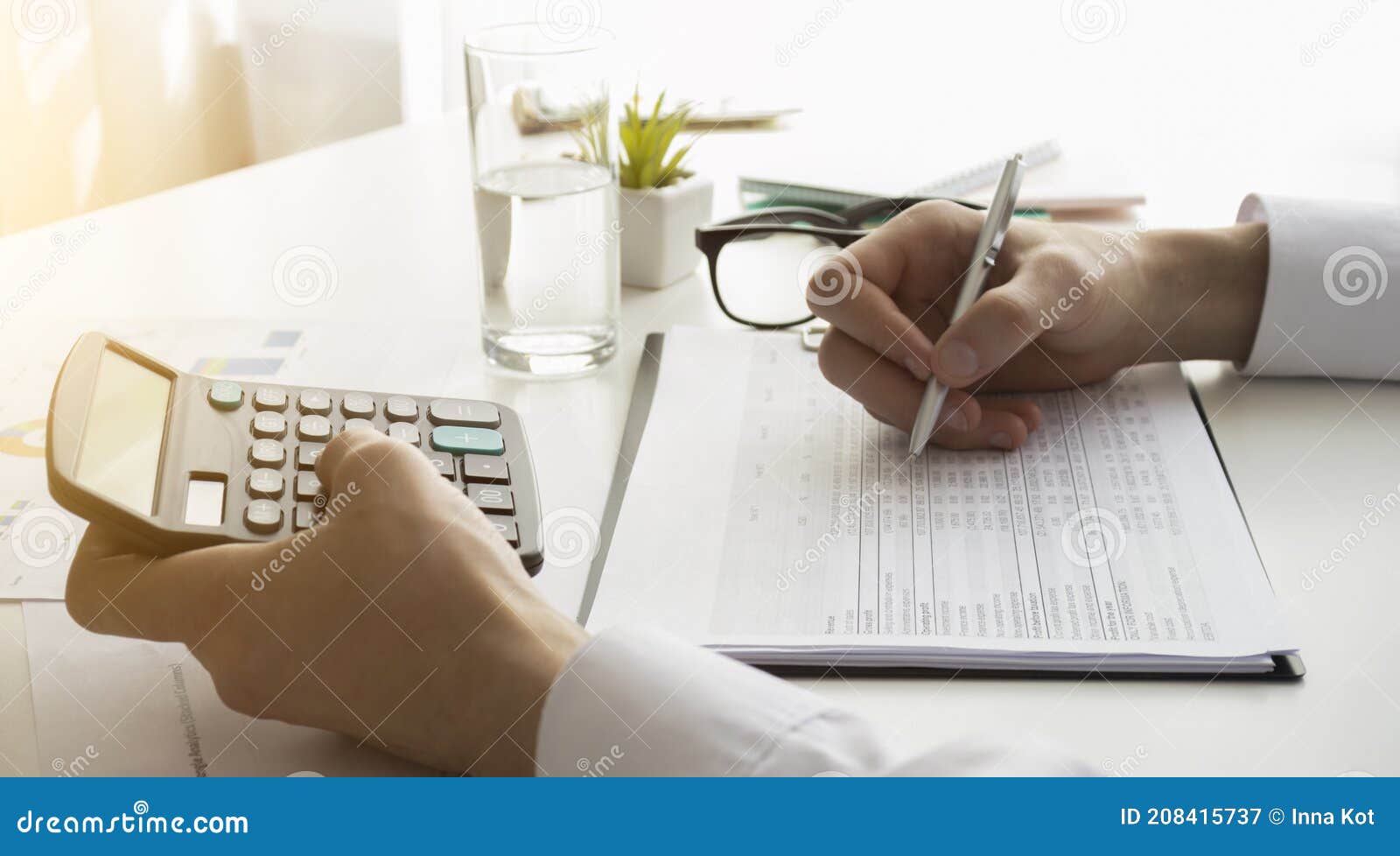 Businessman Working on Office Desk with Calculator, a Pen and Document ...