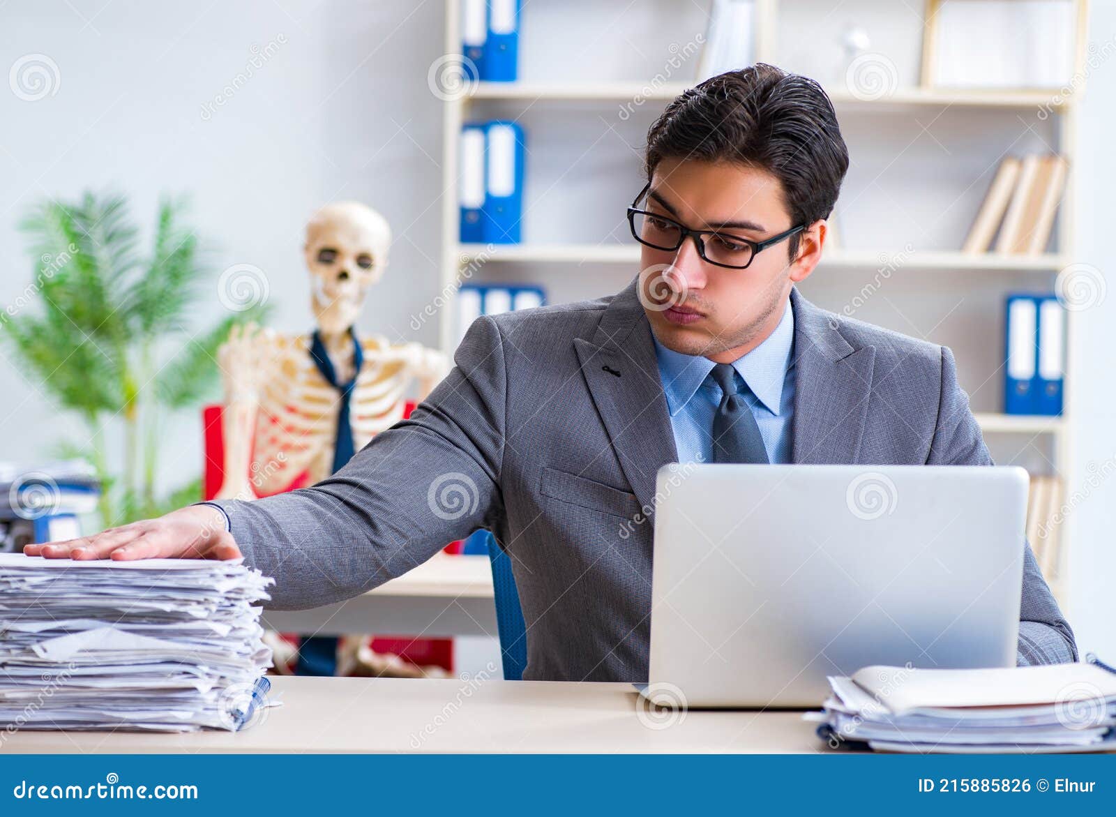 Businessman Working with Skeleton in Office Stock Photo - Image of ...