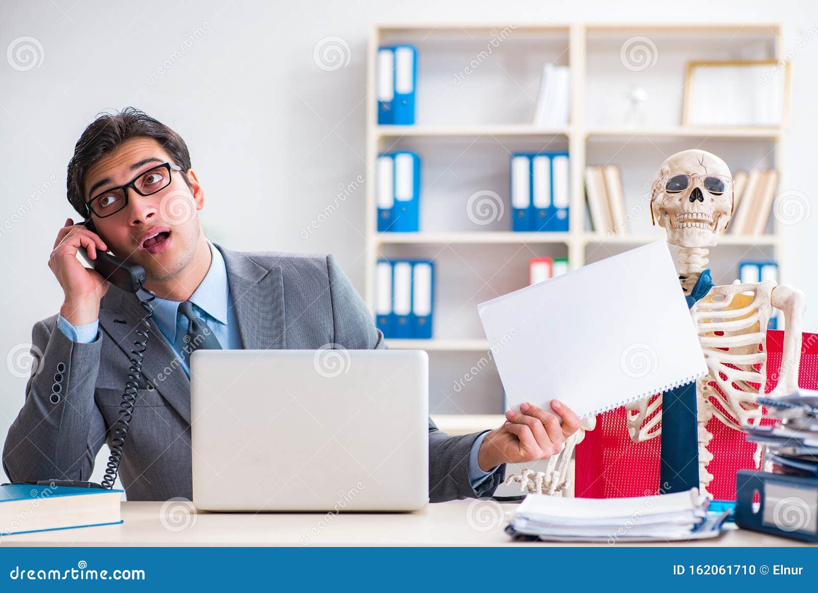 Businessman Working with Skeleton in Office Stock Photo - Image of ...