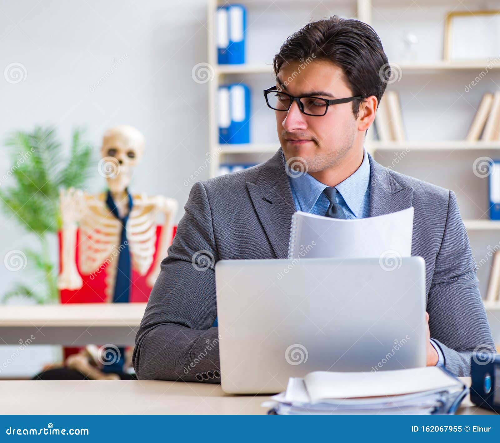 Businessman Working with Skeleton in Office Stock Image - Image of ...