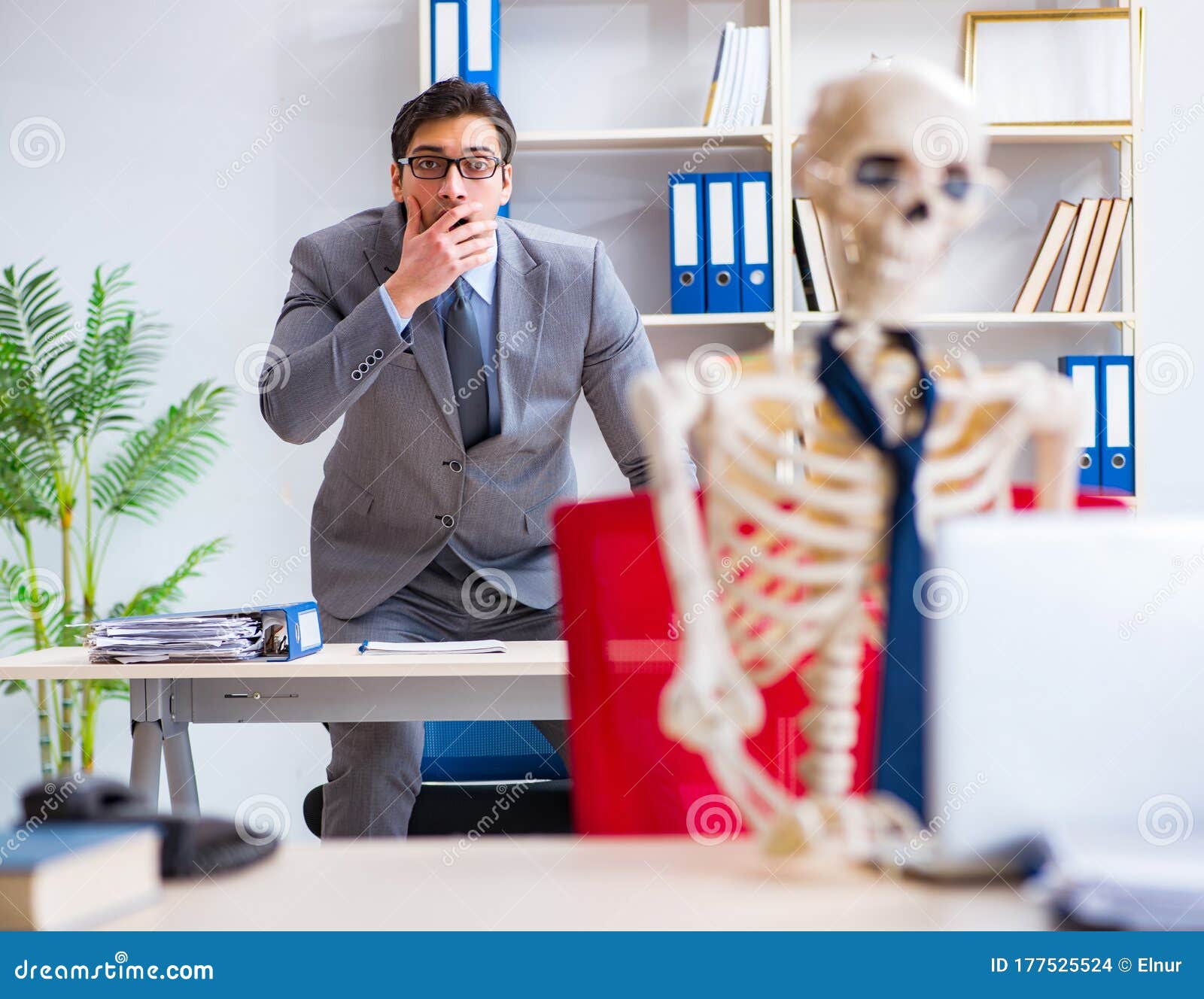 Businessman Working with Skeleton in Office Stock Photo - Image of ...