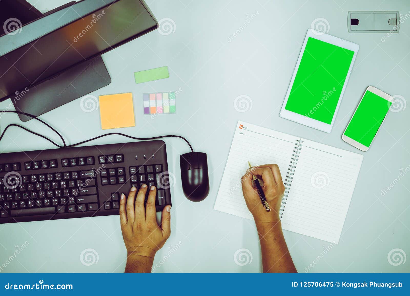 Businessman Working by Using Computer and Also Taking Memo on Notebook ...