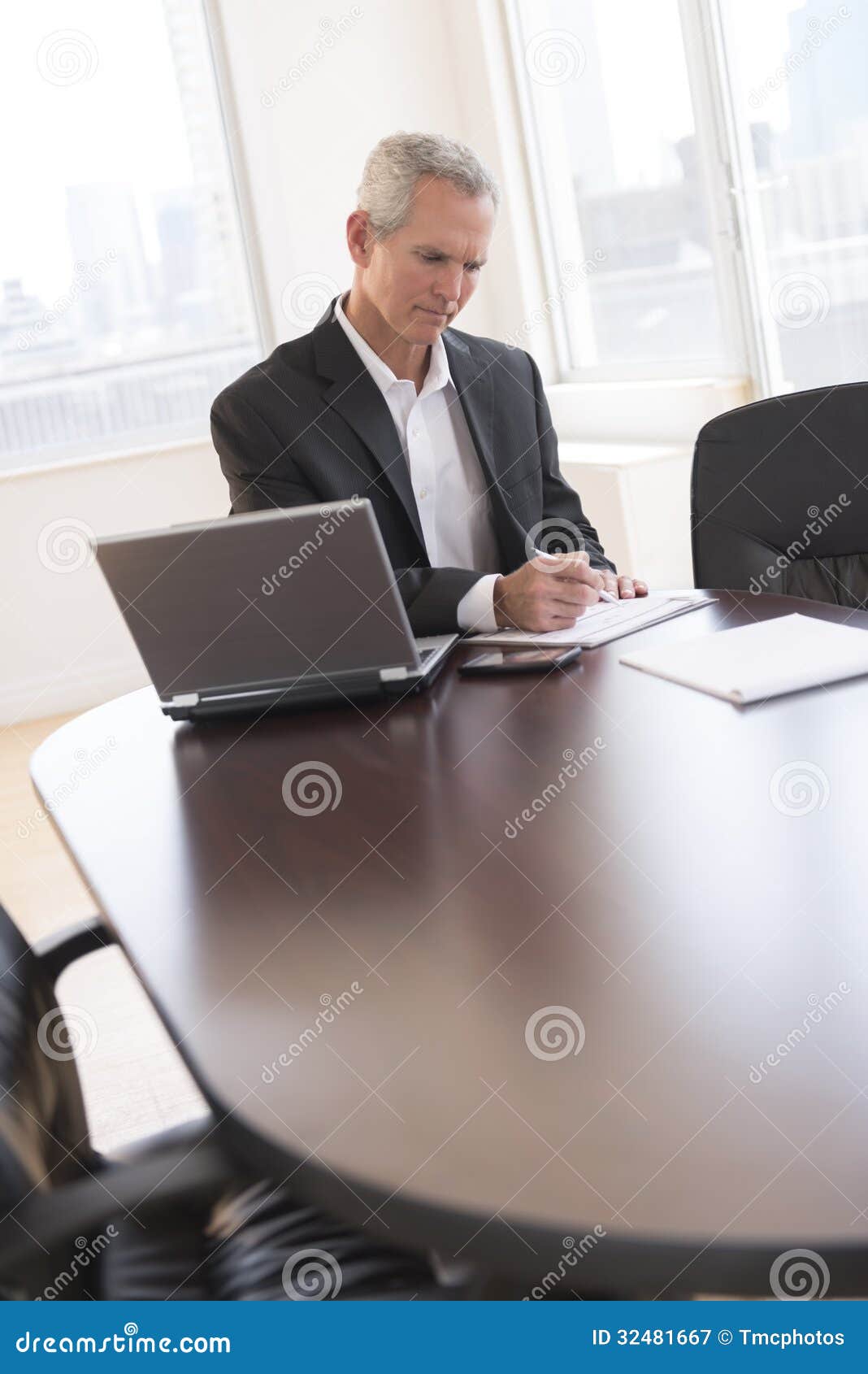 Businessman Writing on Document at Desk Stock Image - Image of ...
