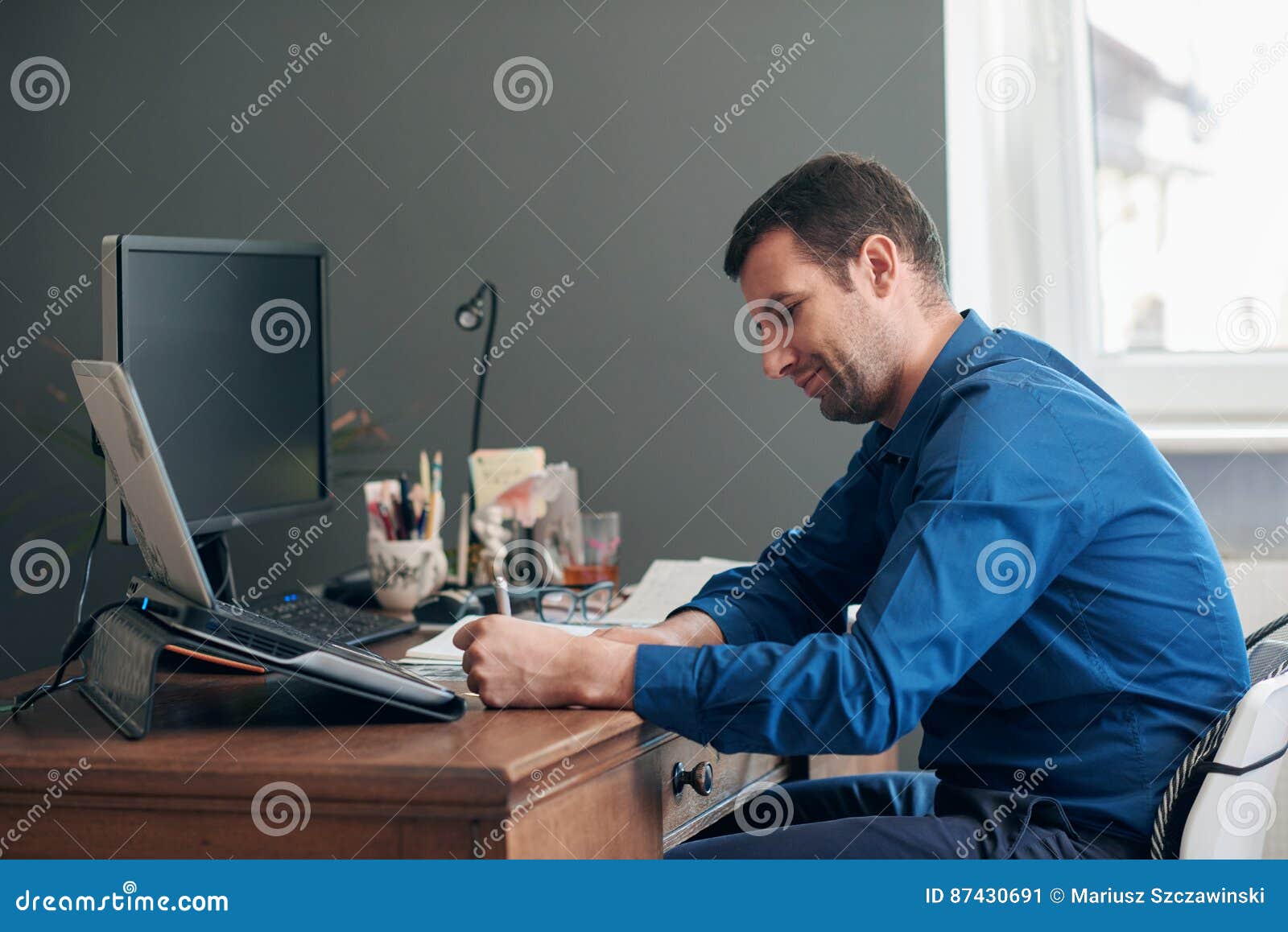 Businessman Writing Documents at an Office Desk Stock Image - Image of ...
