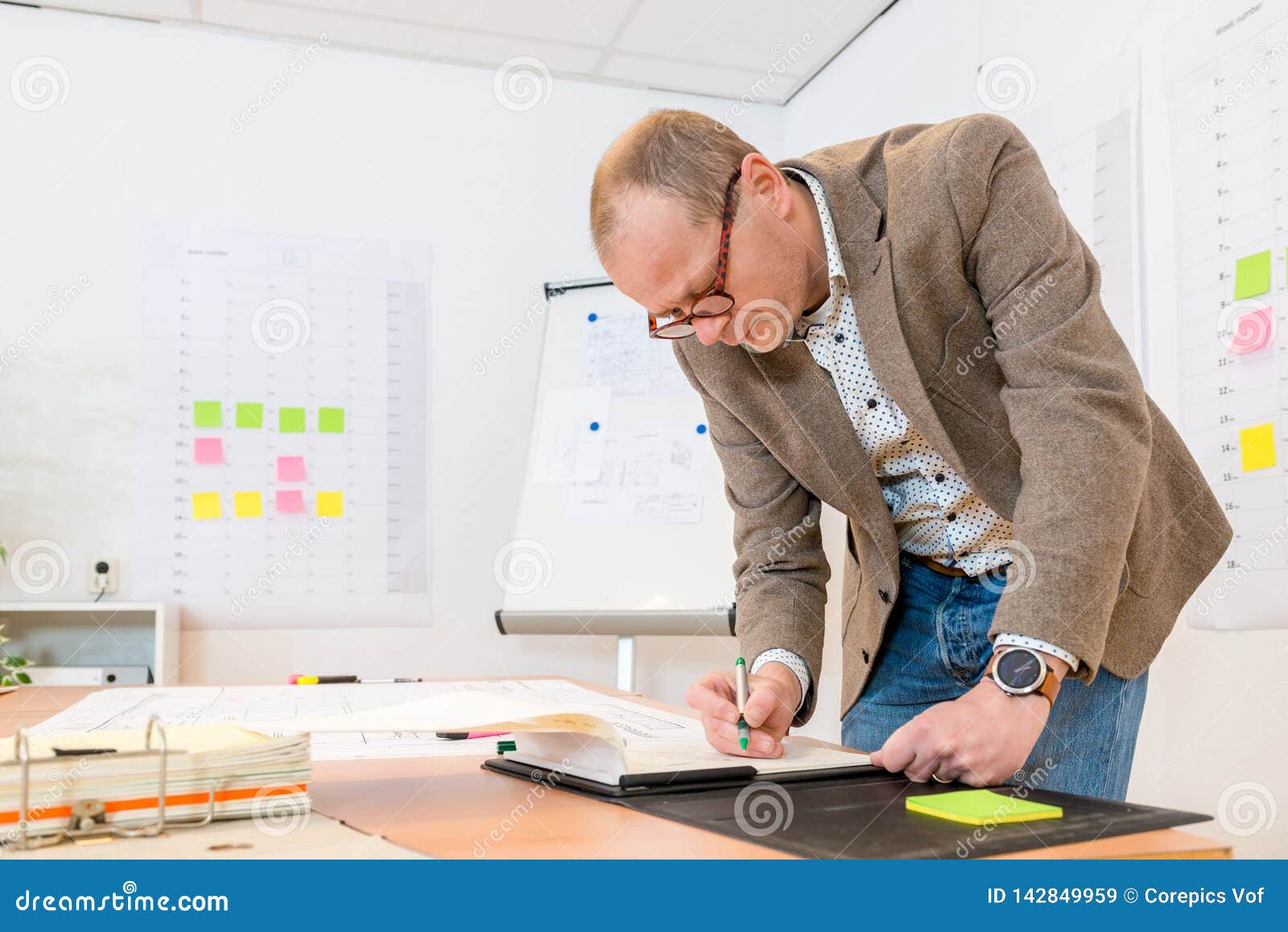 Businessman Writing on Notepad at Desk Stock Image - Image of blazer ...