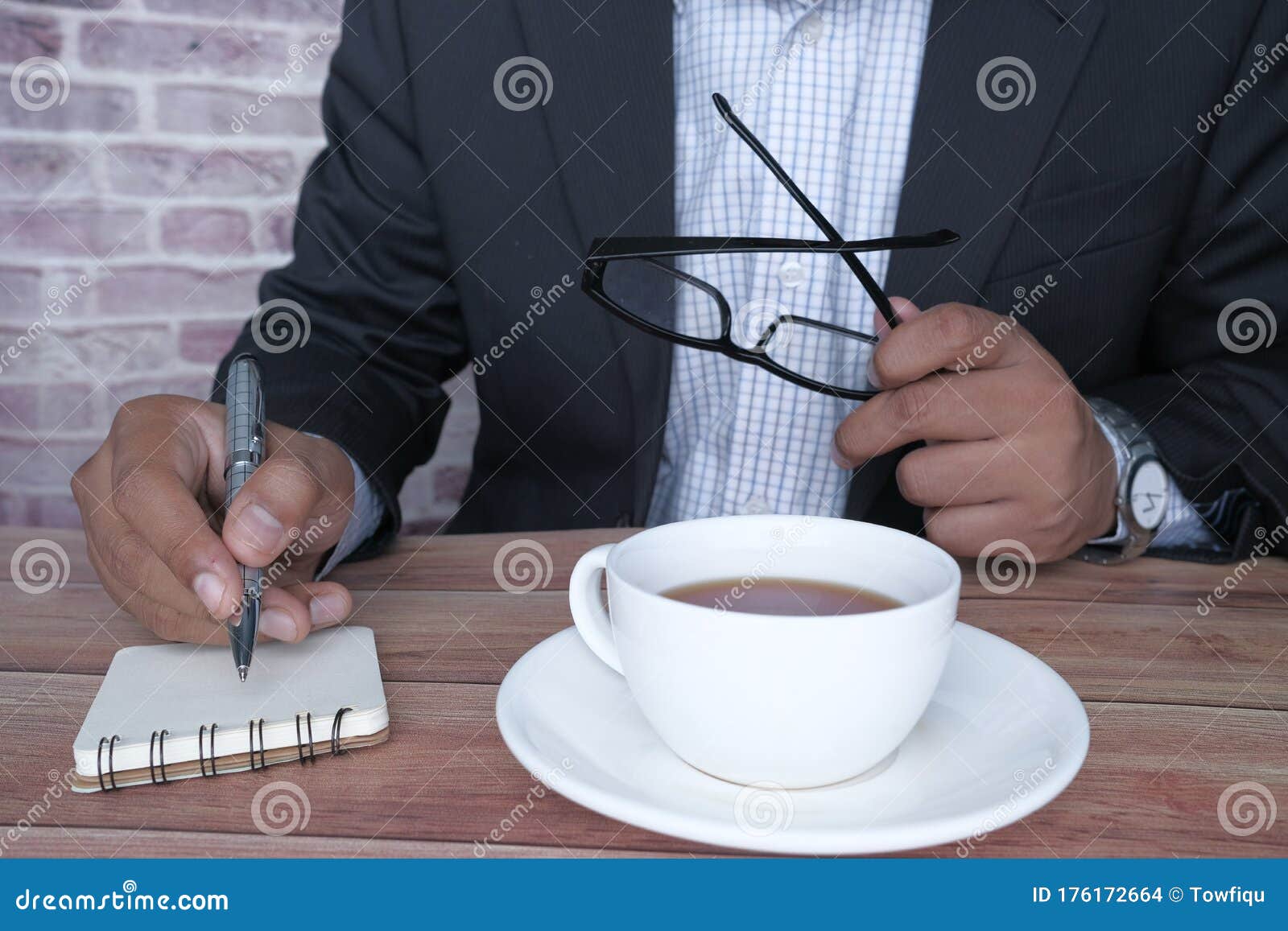 Businessman Writing on Notepad on Table at Office Table Stock Photo ...
